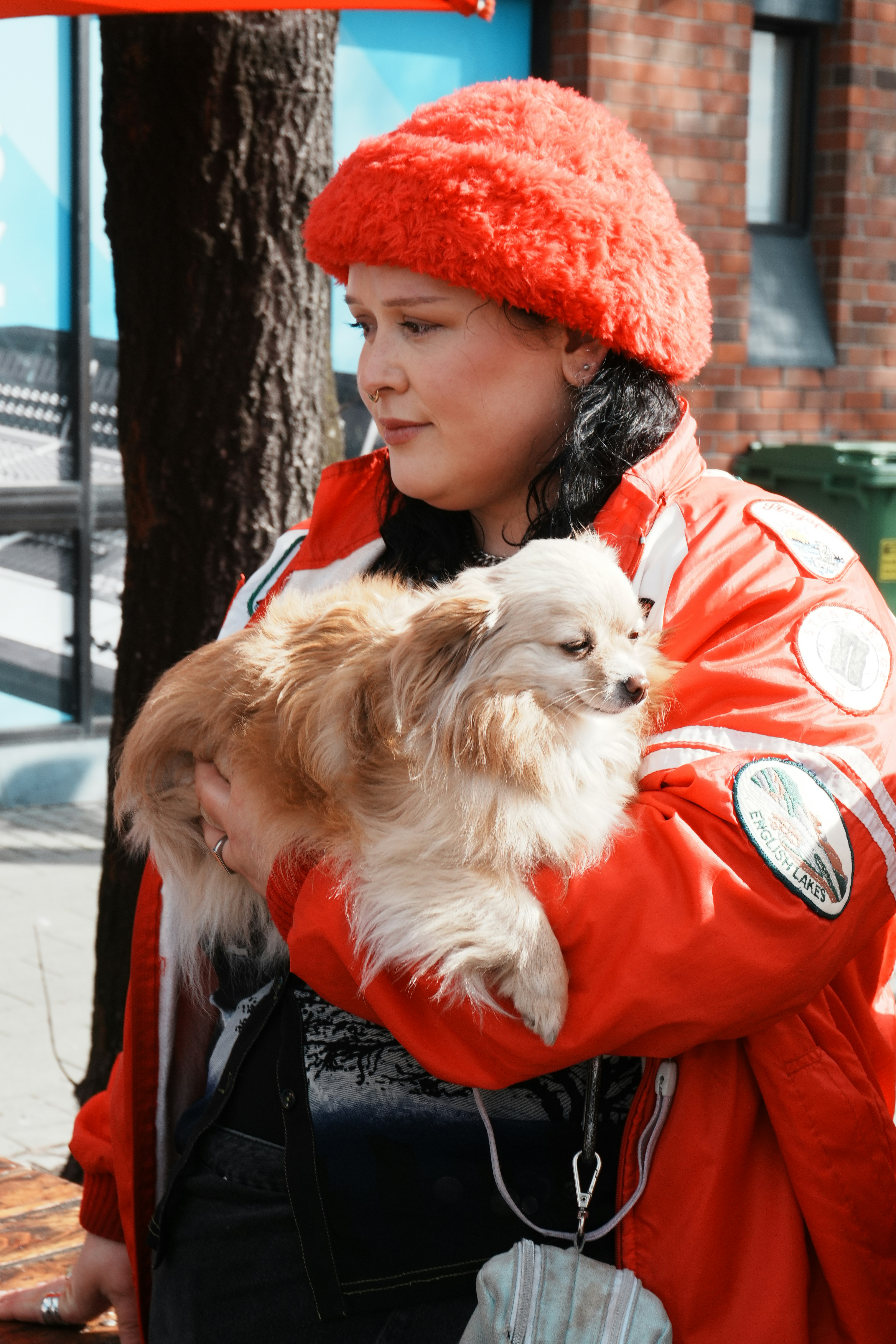 Red Jacket, Gentle Paws: A Moment of Quiet Compassion