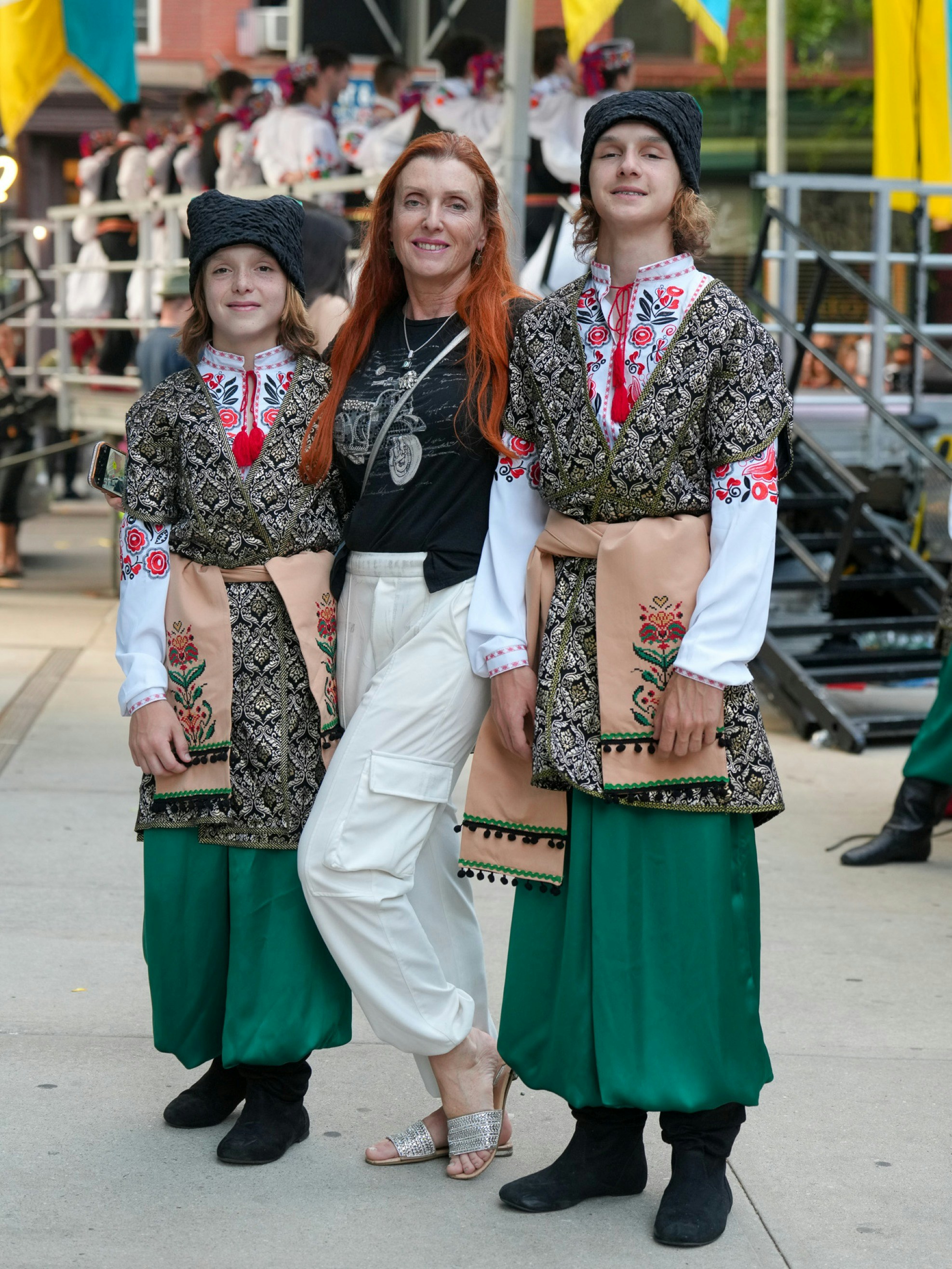 Three Generations in Traditional Garb at a Street Festival