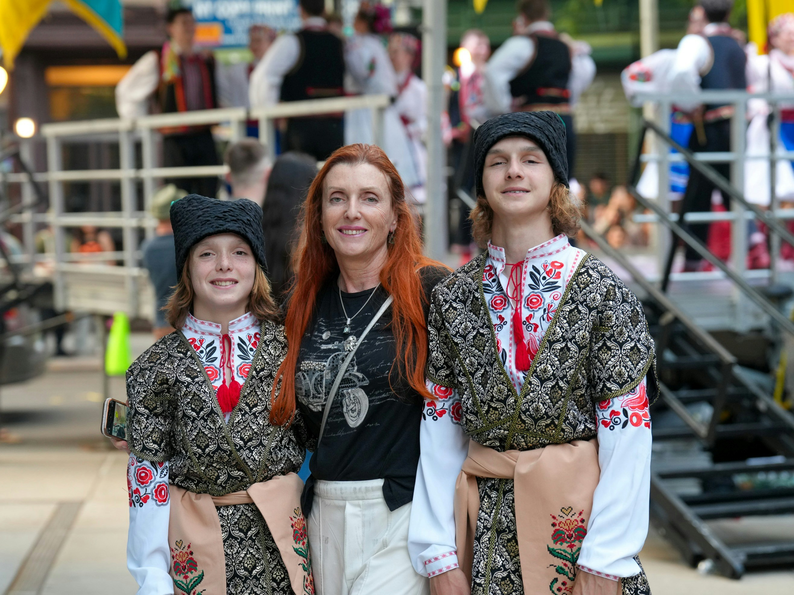 Red-haired Matriarch with Two Traditional Attendants at a Cultural Event