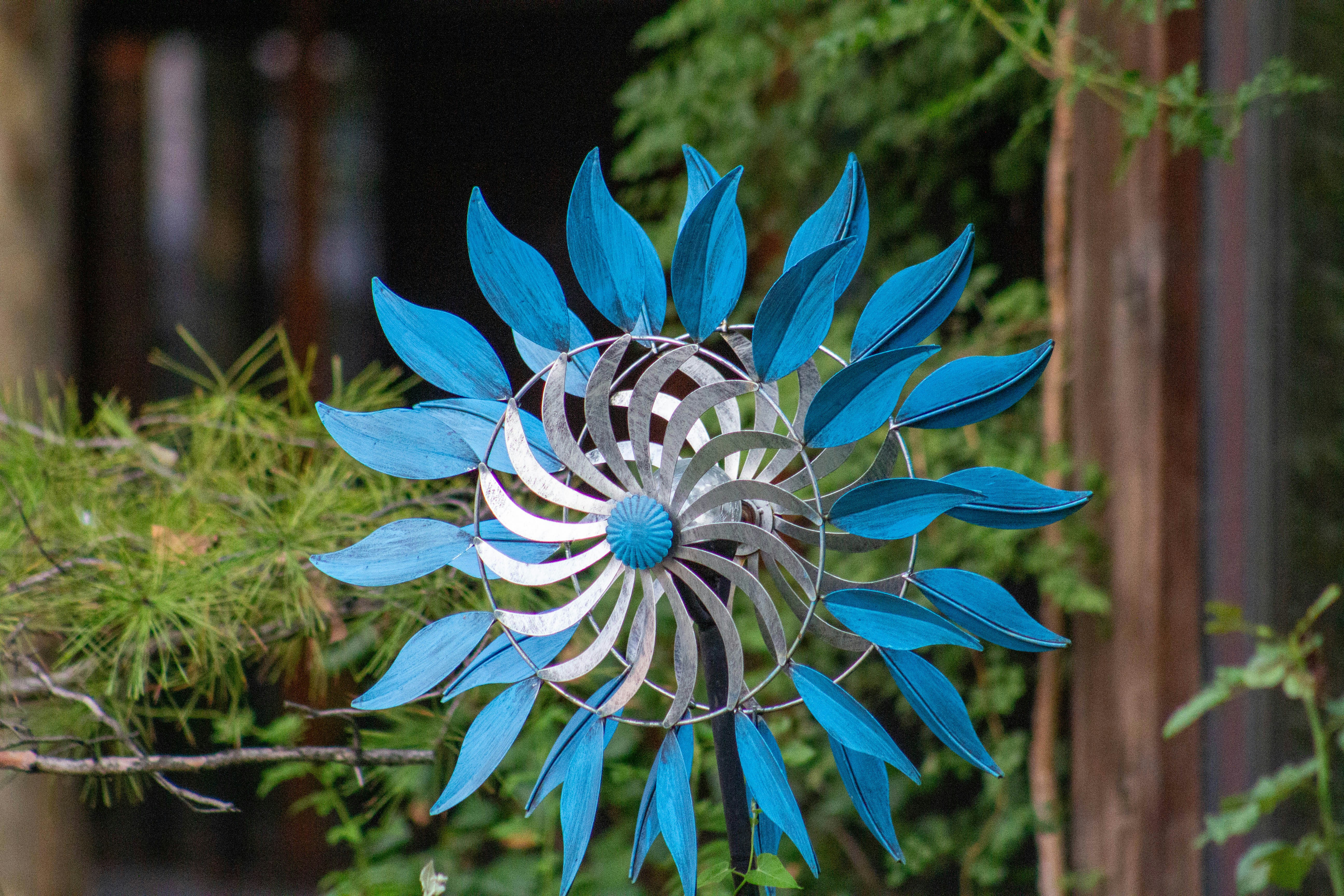 Cerulean Whirlwind: A Blue Wind Spinner in Quiet Garden Light