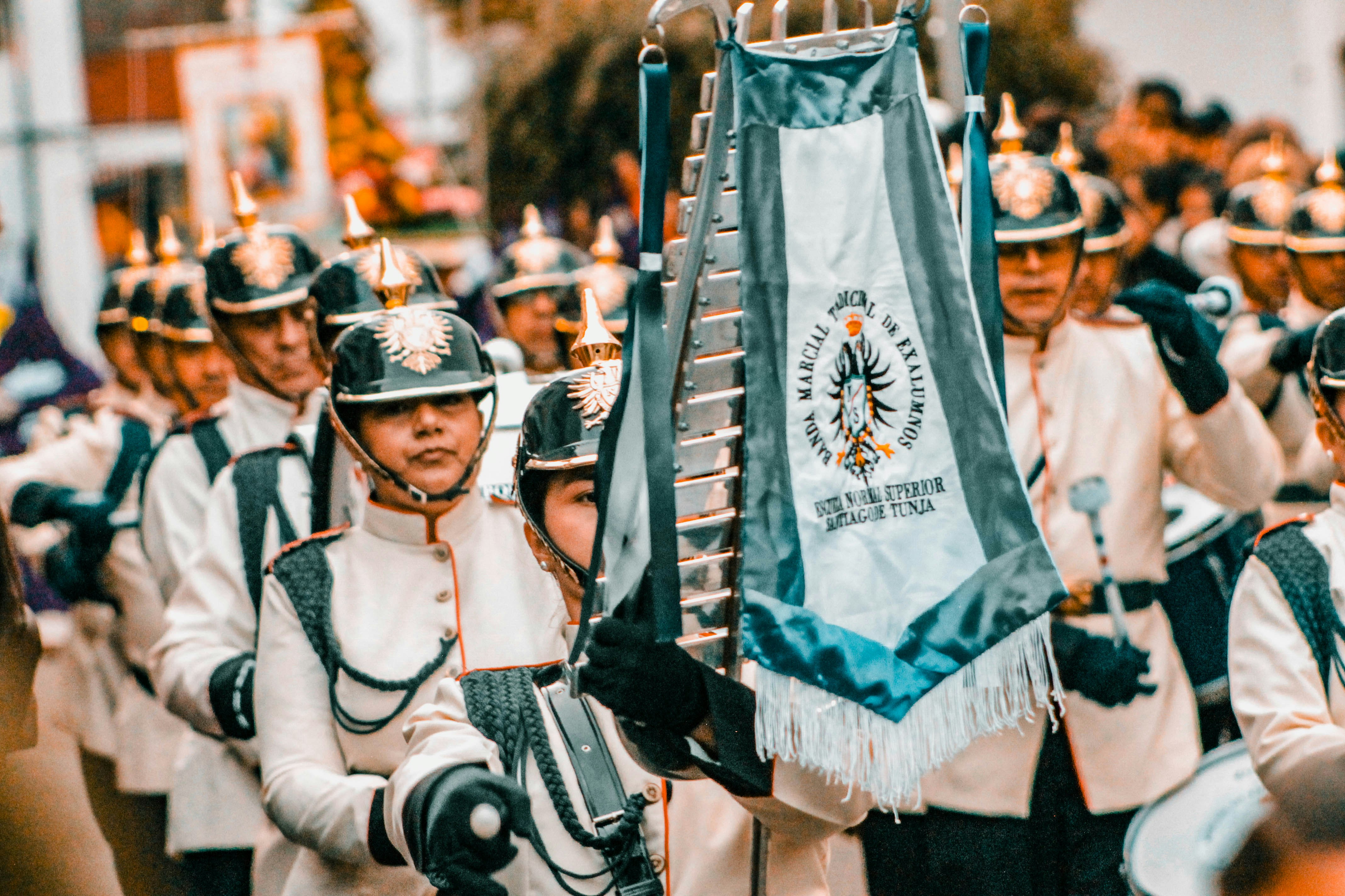 Marching Banner Bearer: A Formal Procession in White and Teal