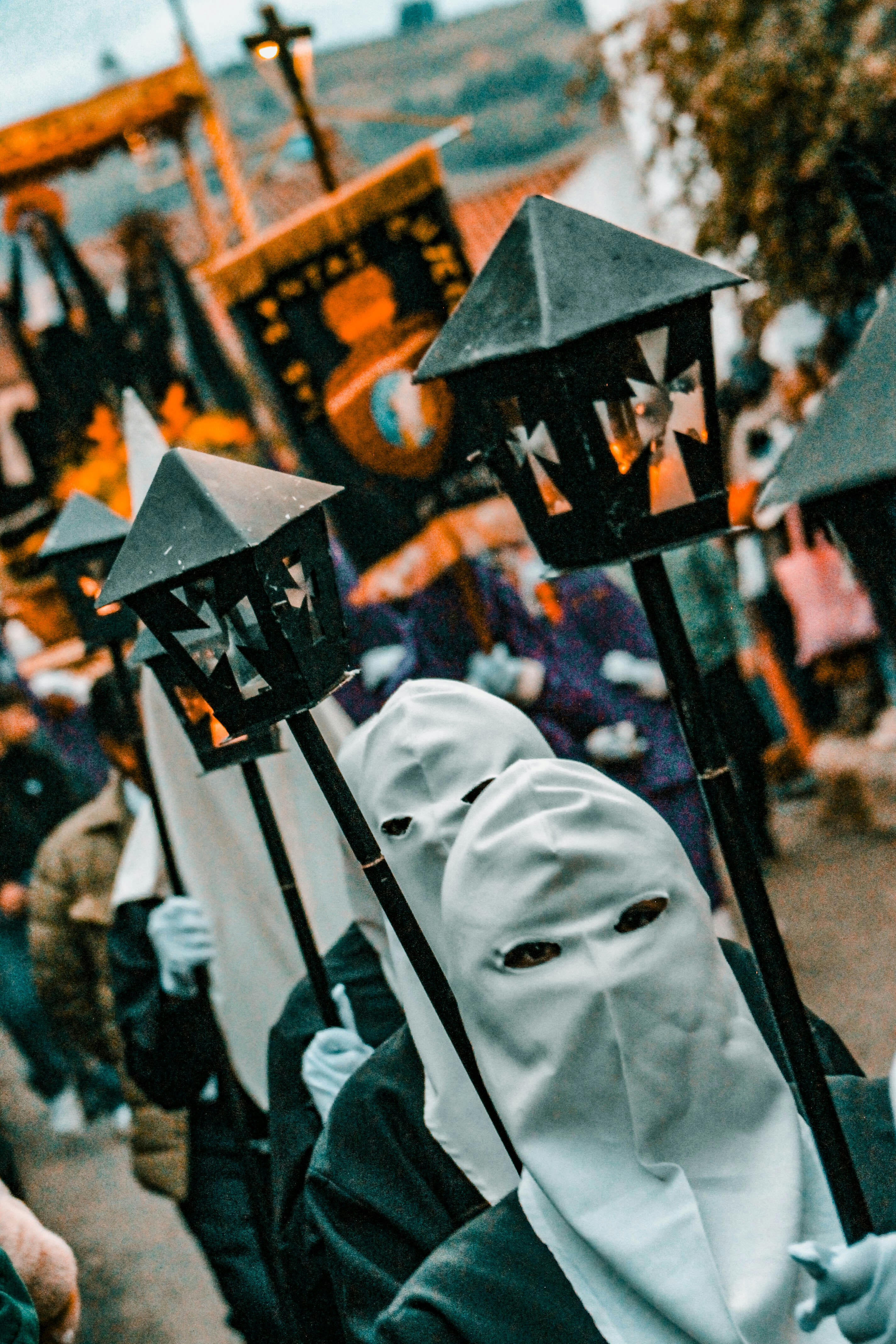 Masked Procession: Ghostly Figures March Through Lantern-lit Street