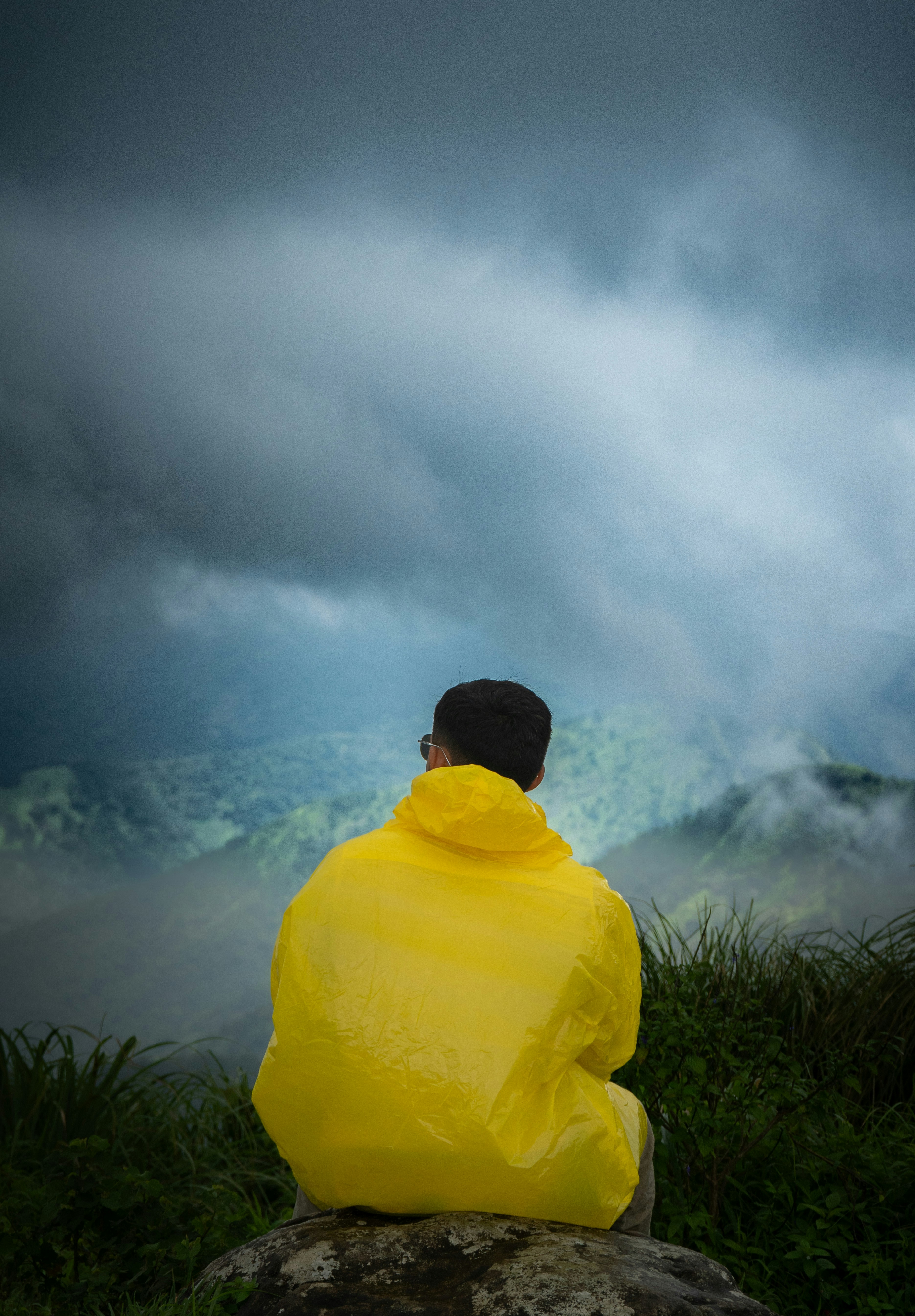 Yellow Cloak on the Edge: Solitary View Above the Clouds