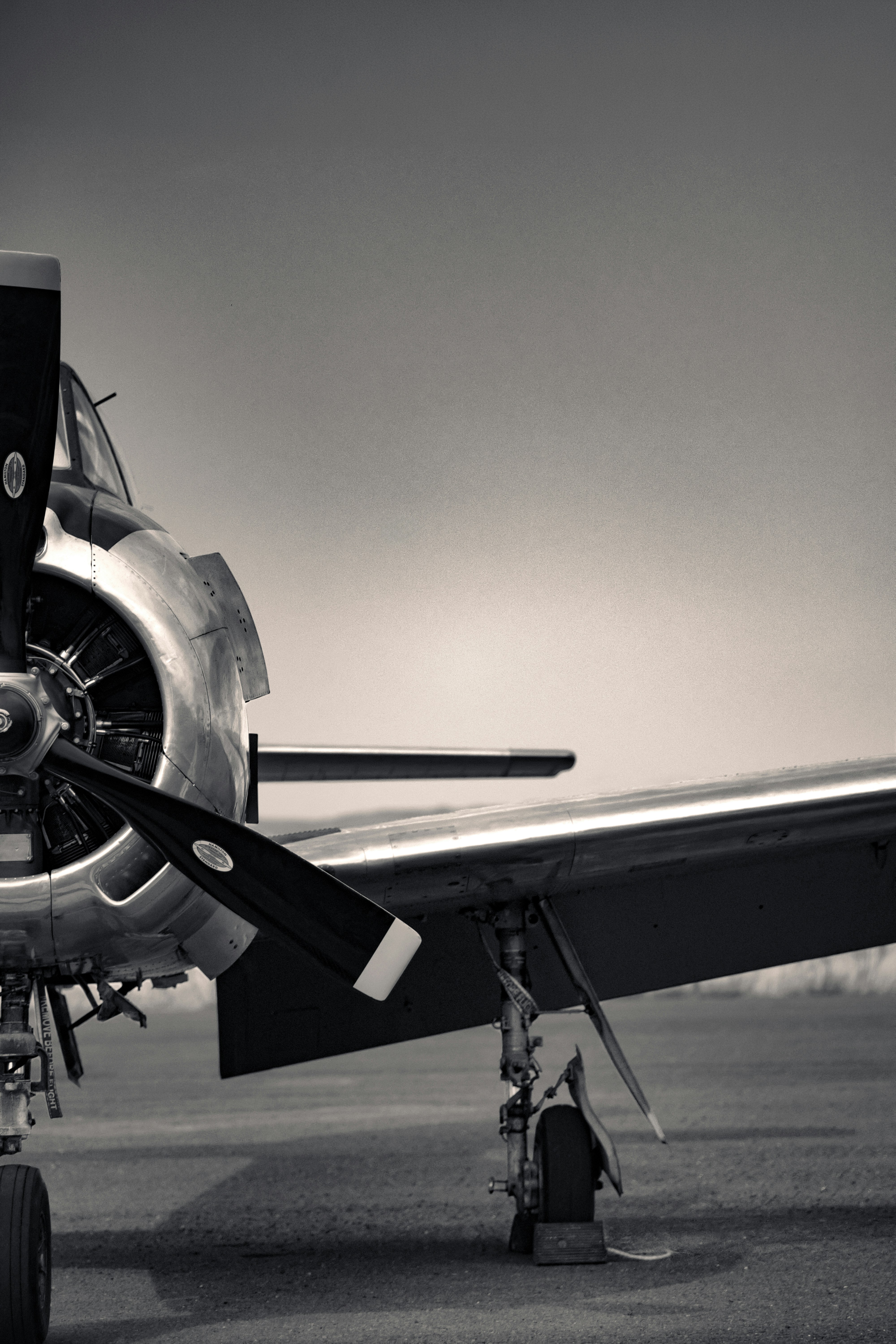 Propeller Pinwheel: Front-Quarter View of a Vintage Aircraft on the Tarmac