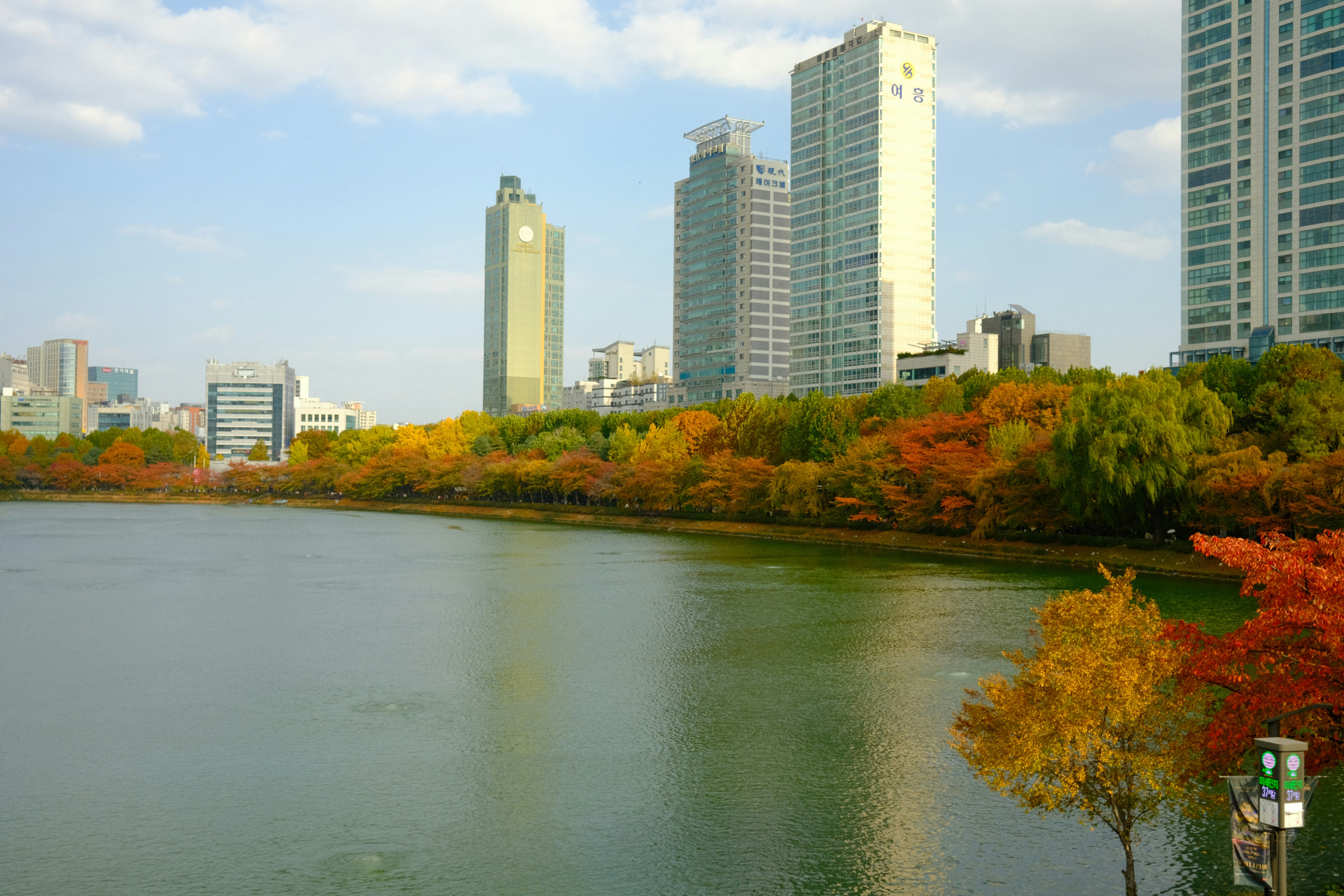Autumn River Skyline: Cityscape Reflected in Calm Waters