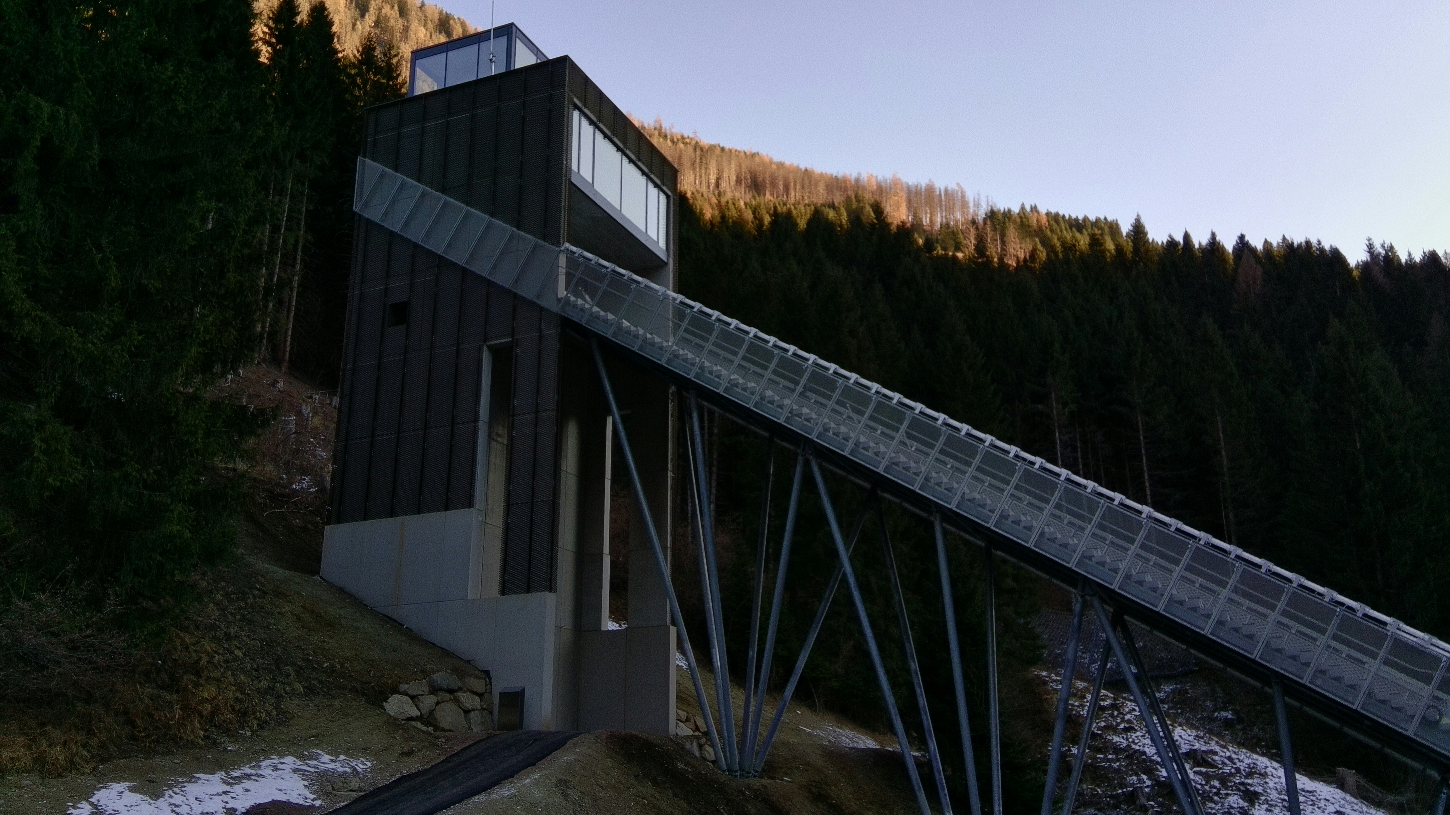 Elevator to the Timber Edge: A modern cableway perched on a hillside