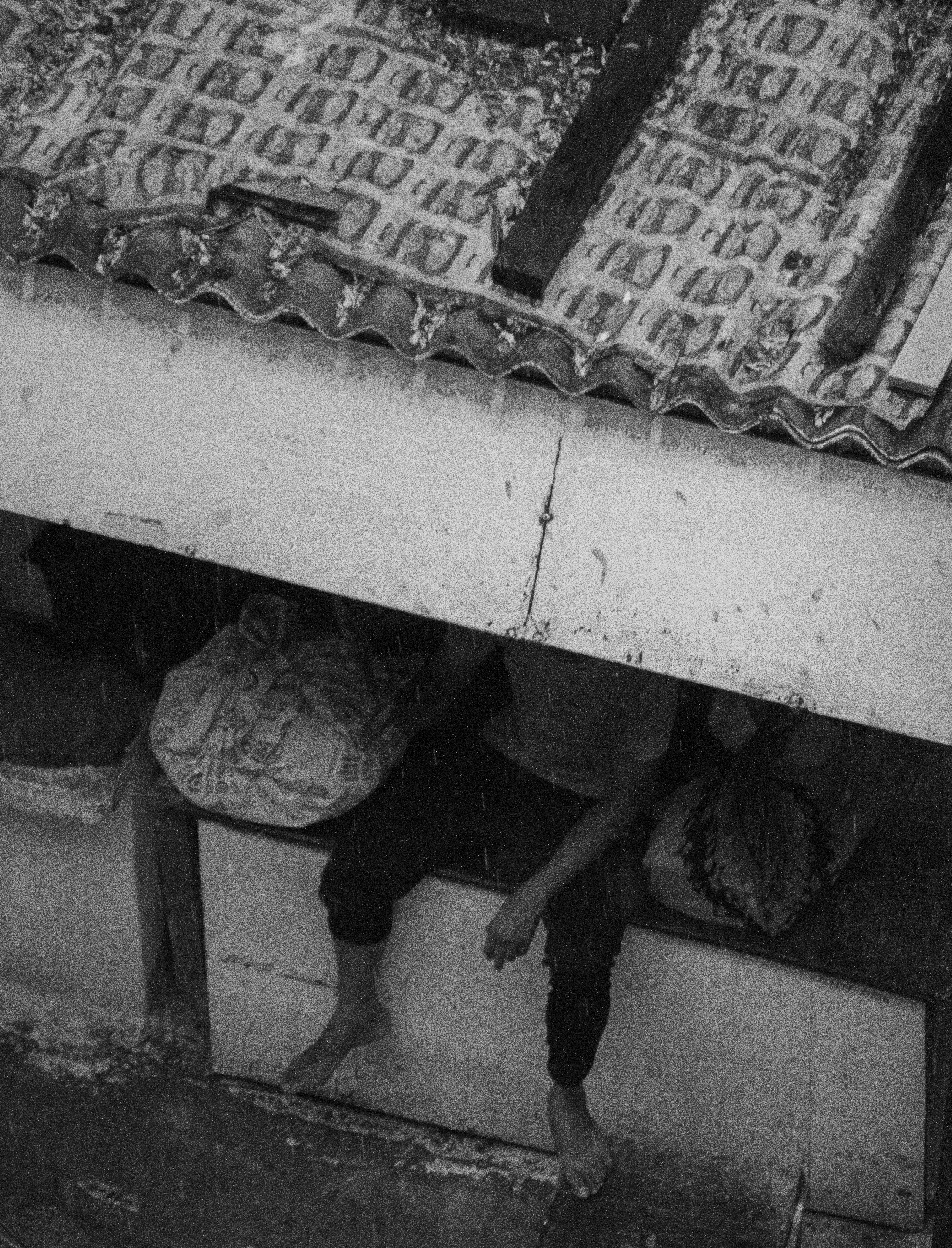 Shaded Rooftop Shelter: Bare Feet and a Hidden Moment