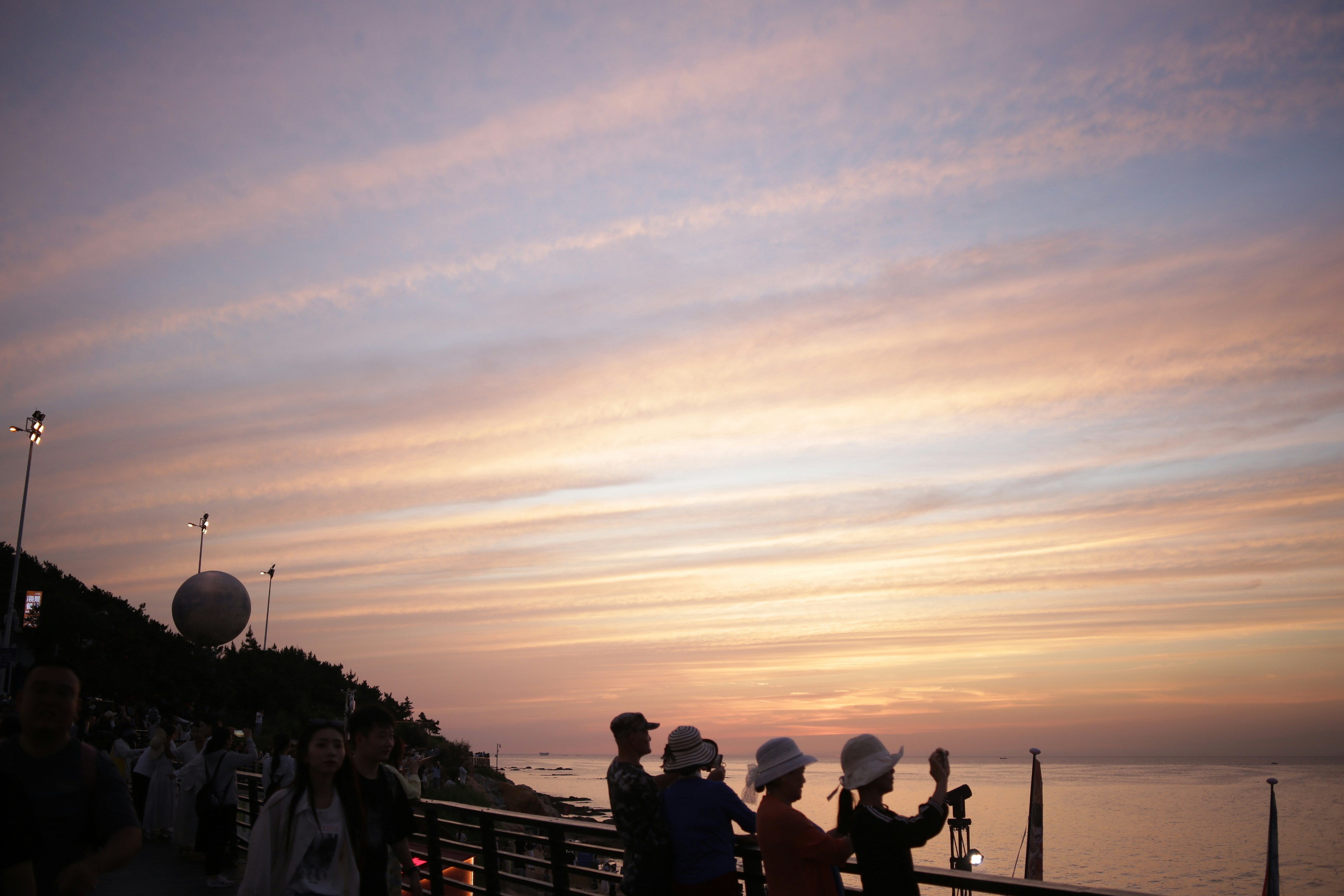 Sunset Promenade: silhouettes and Lanterns Along the Pier