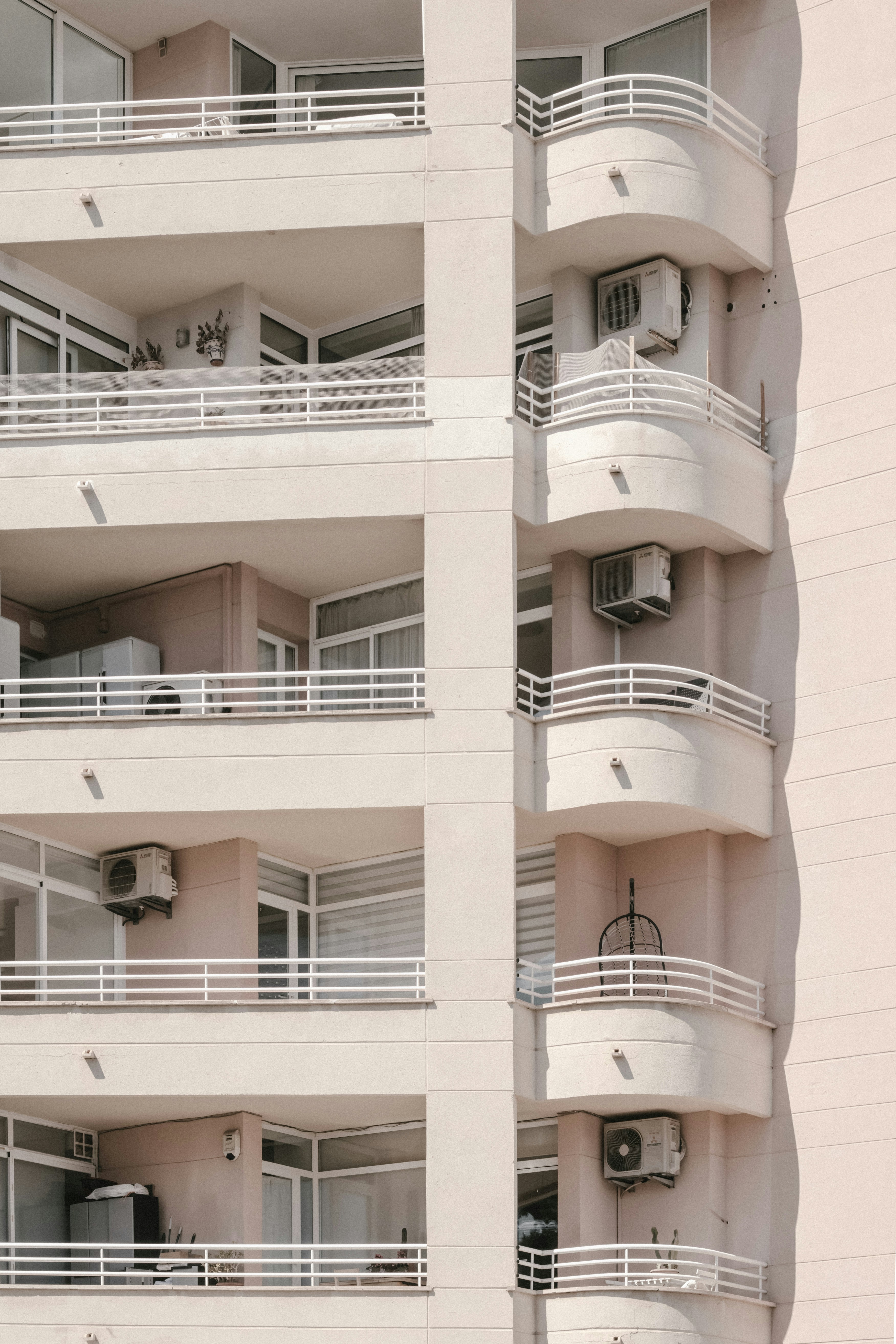 Sunlit Apartment Facade: Repeating Circles and Shadows