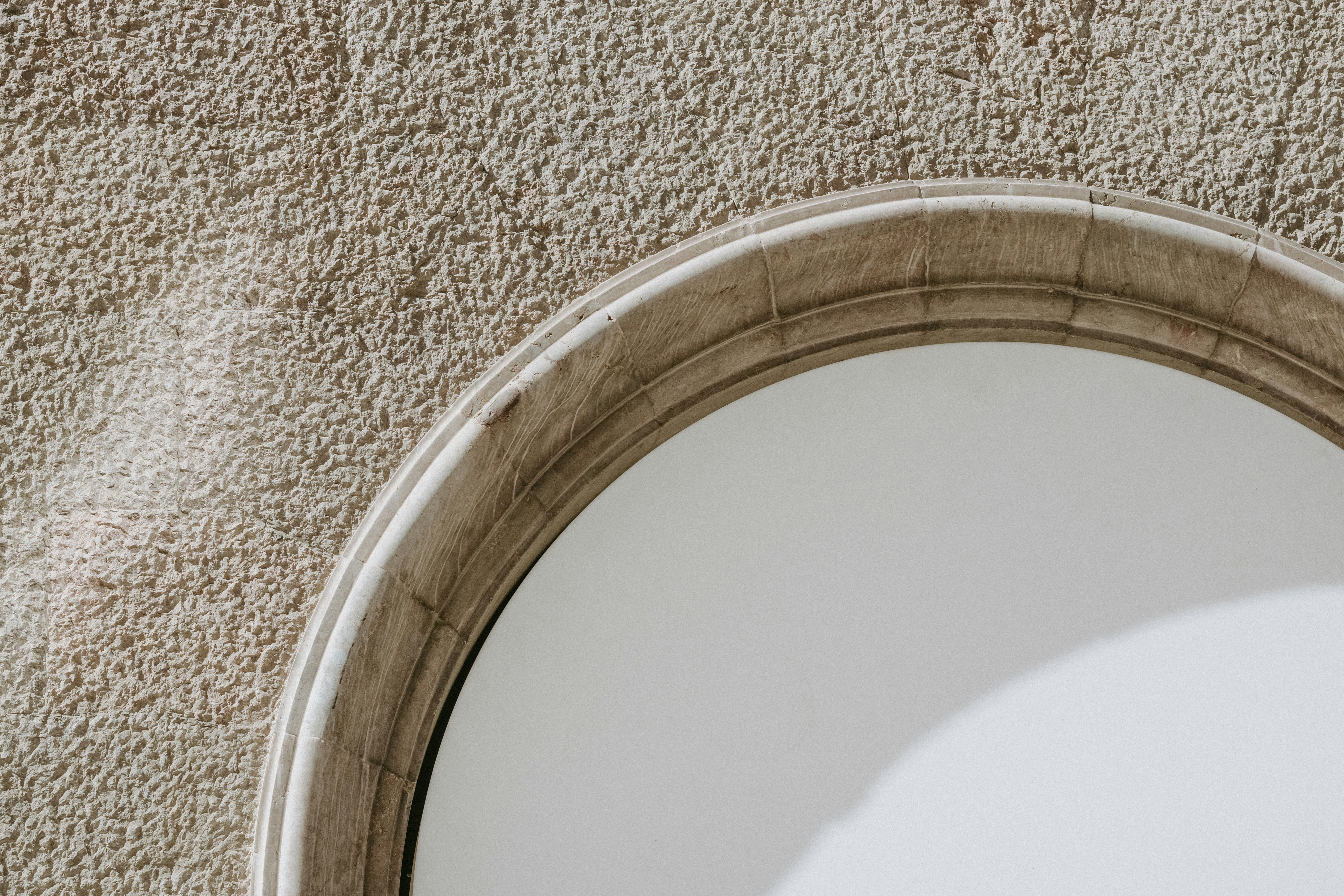 Circular Arch Framing: Concrete Texture and Light Edge
