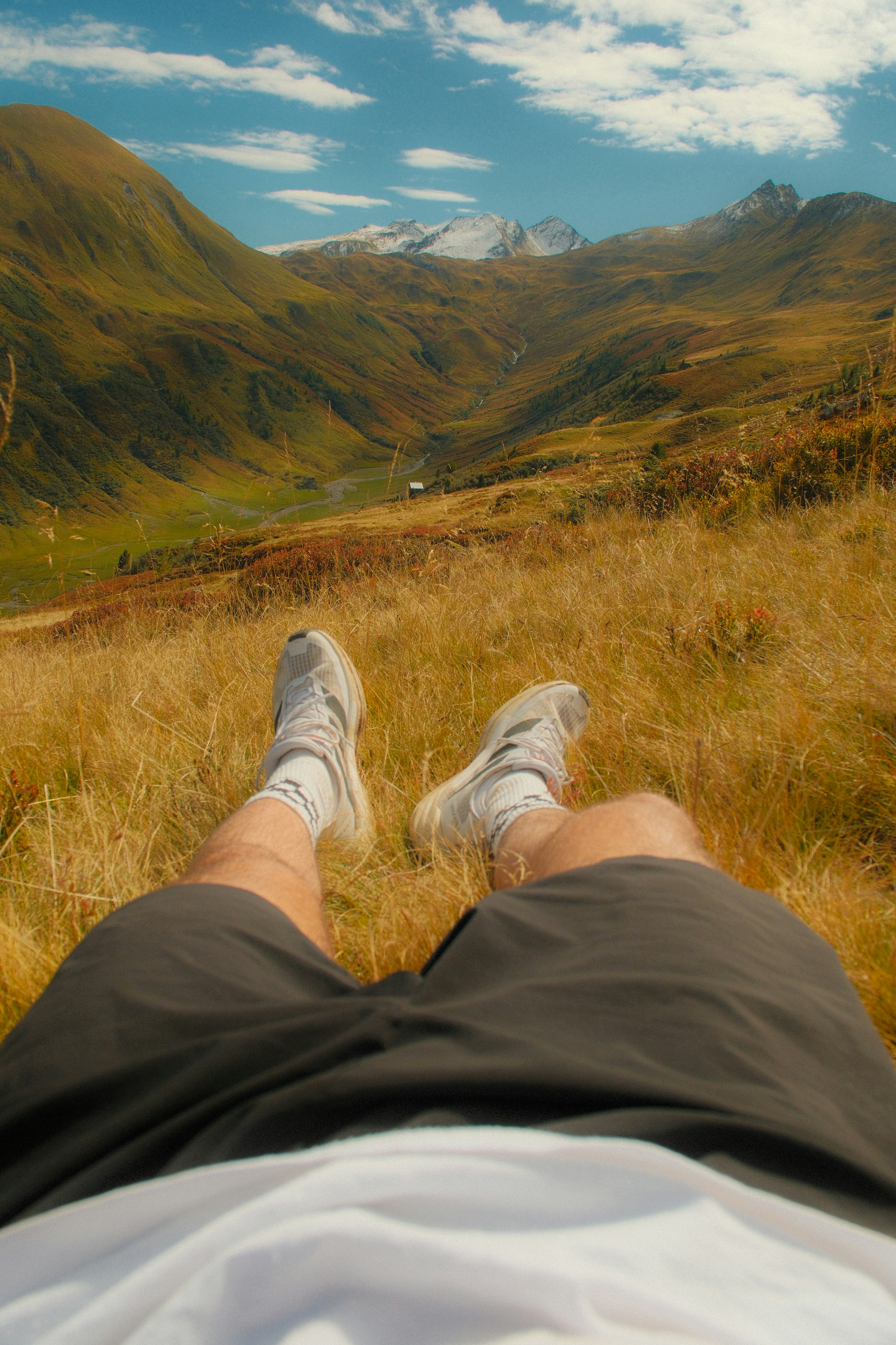 Hiker's Perspective: Boots over a Golden Alpine Valley