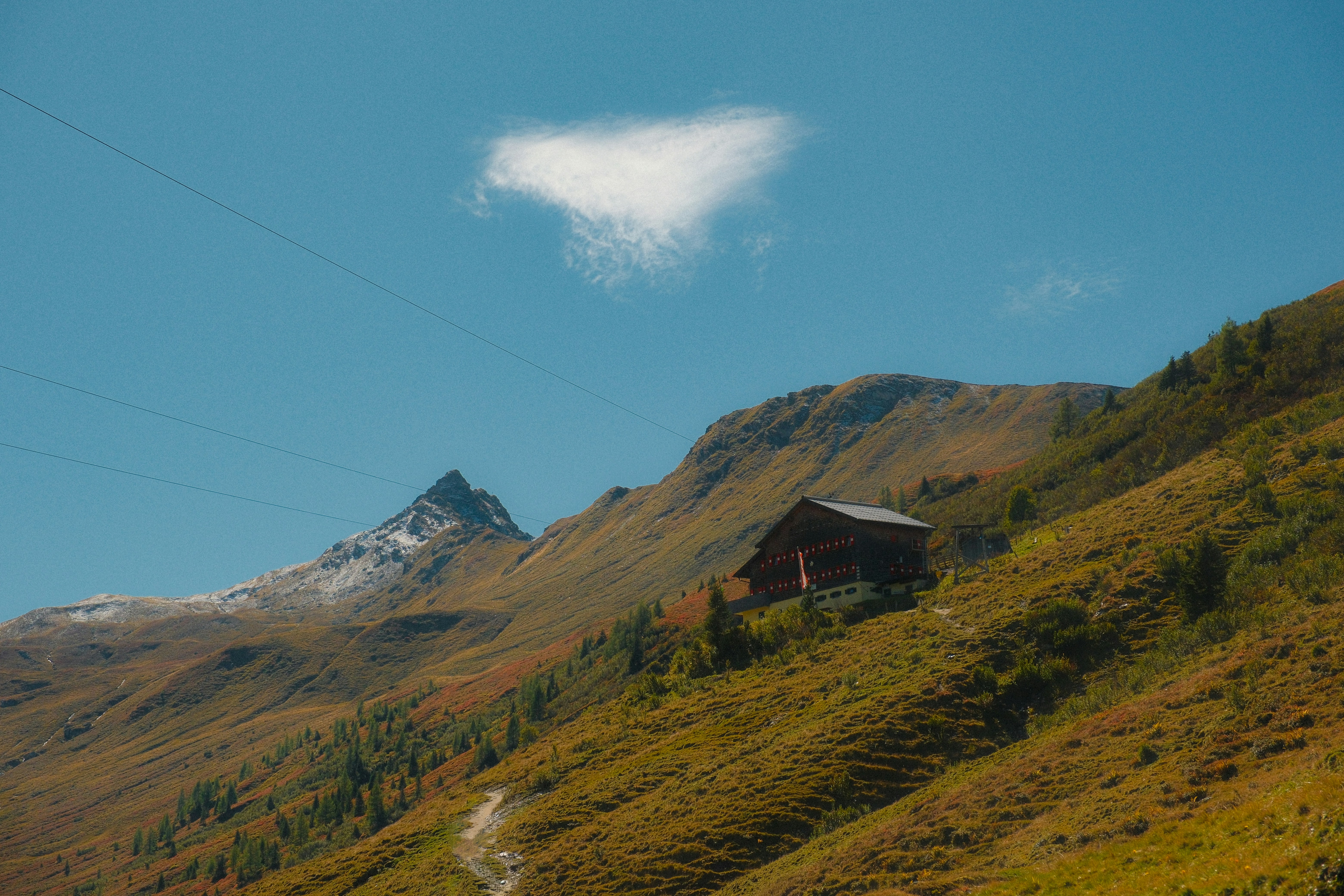 Alpine Refuge Nestled on a Leaning Slope Under a Clear Sky