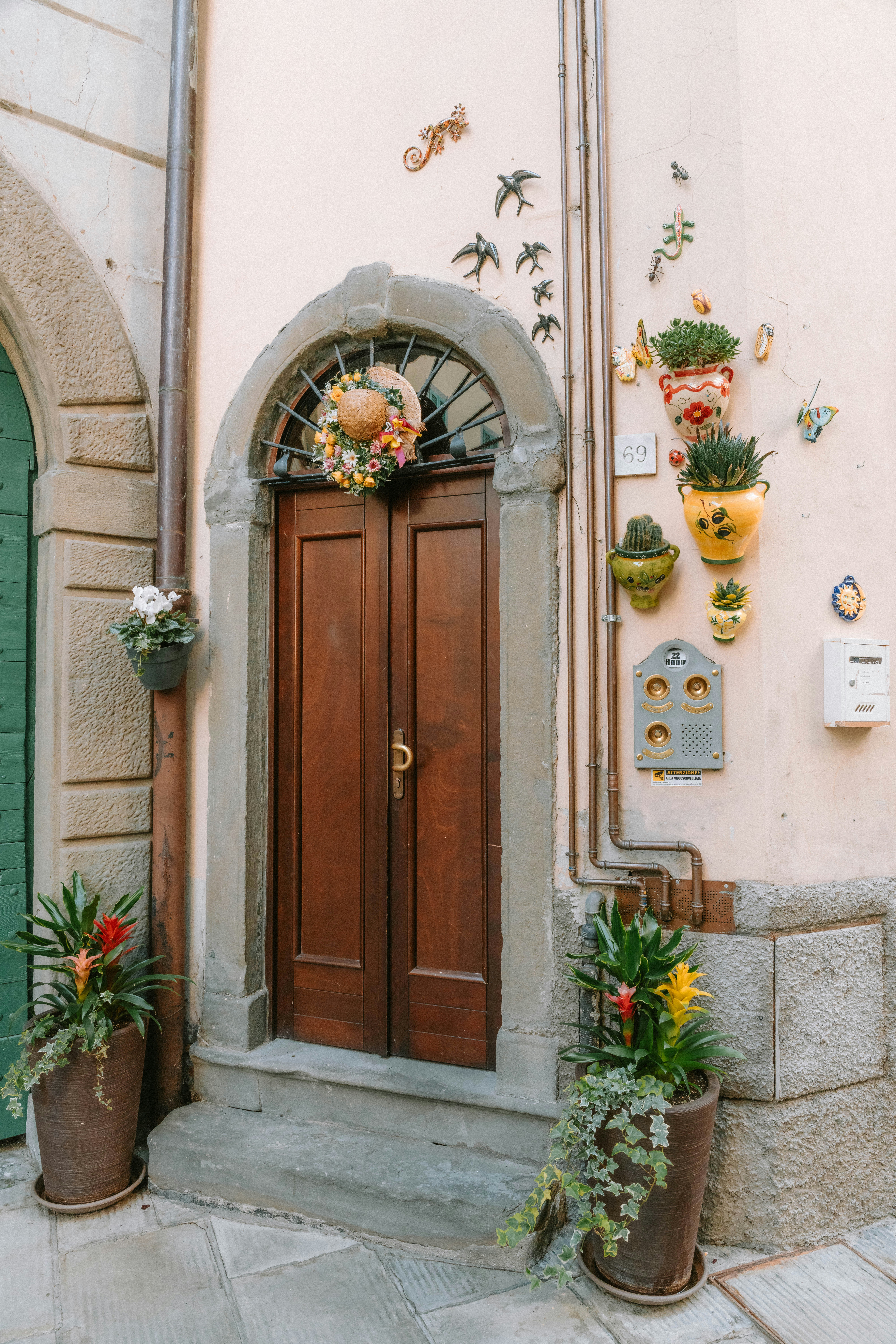 Ceramic pots and a carved doorway: a sunlit courtyard entryway