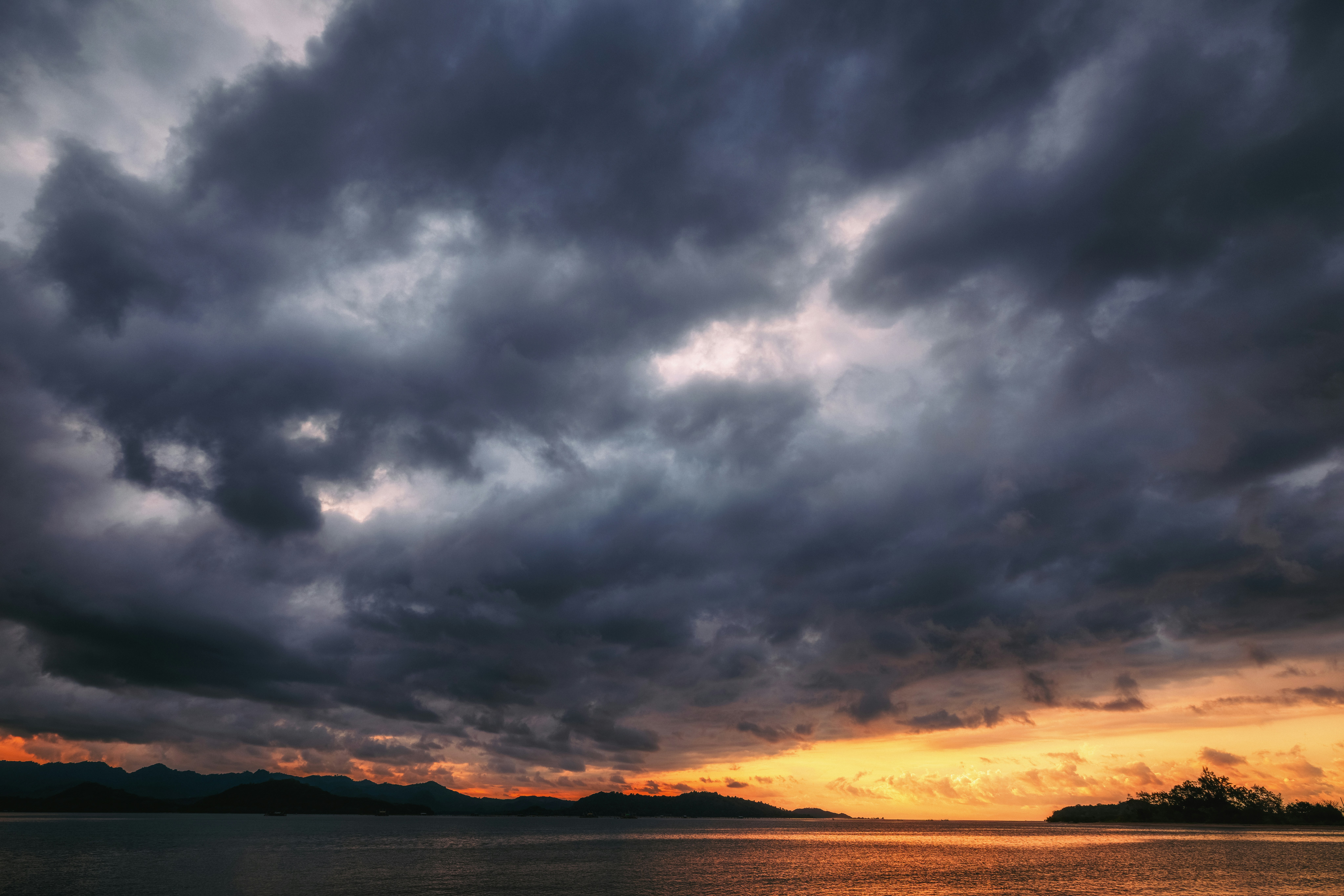 Copper Horizon: Quiet Sunset Over Calm Waters
