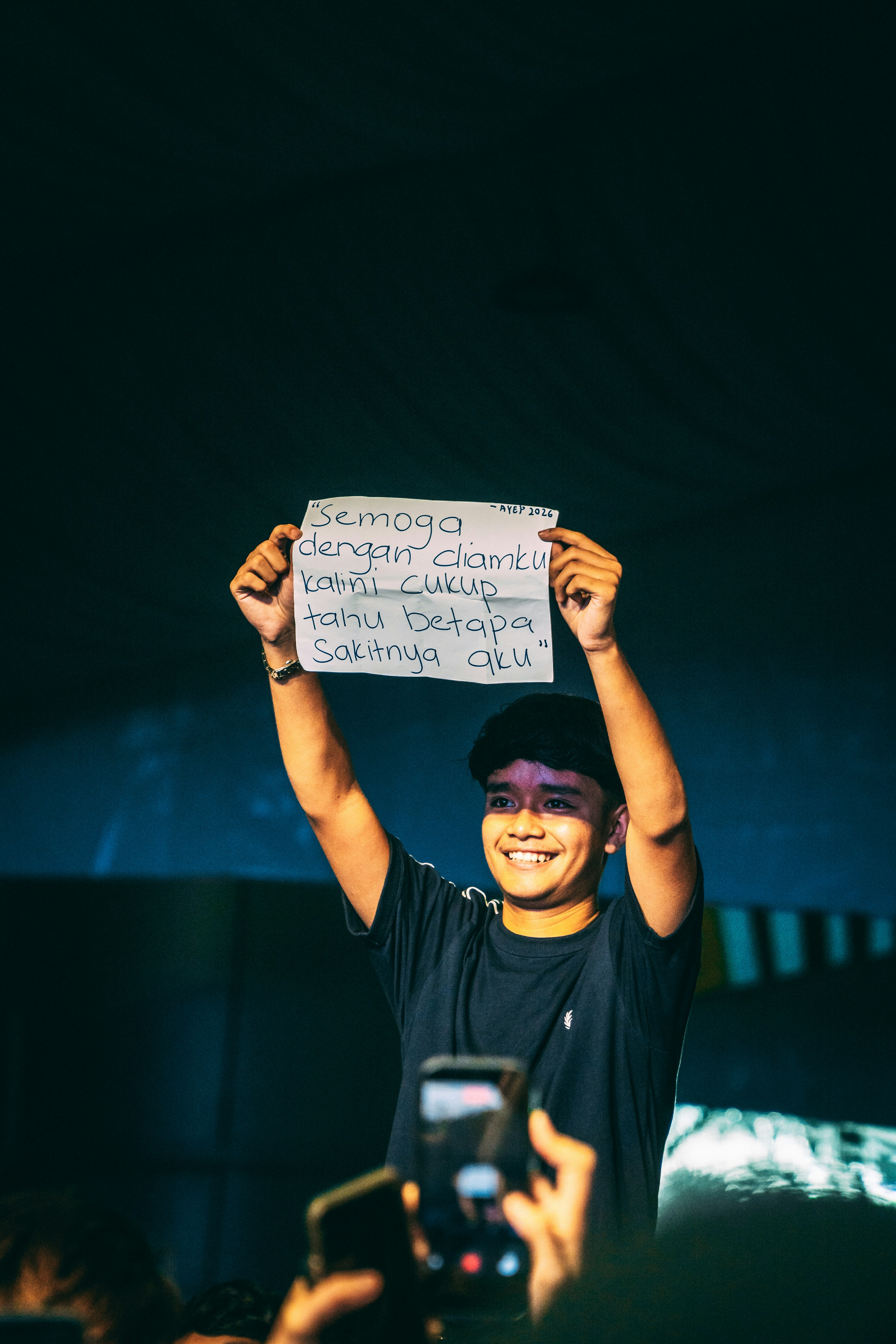 Hands Raised, Message Held High: Youthful Rally Moment