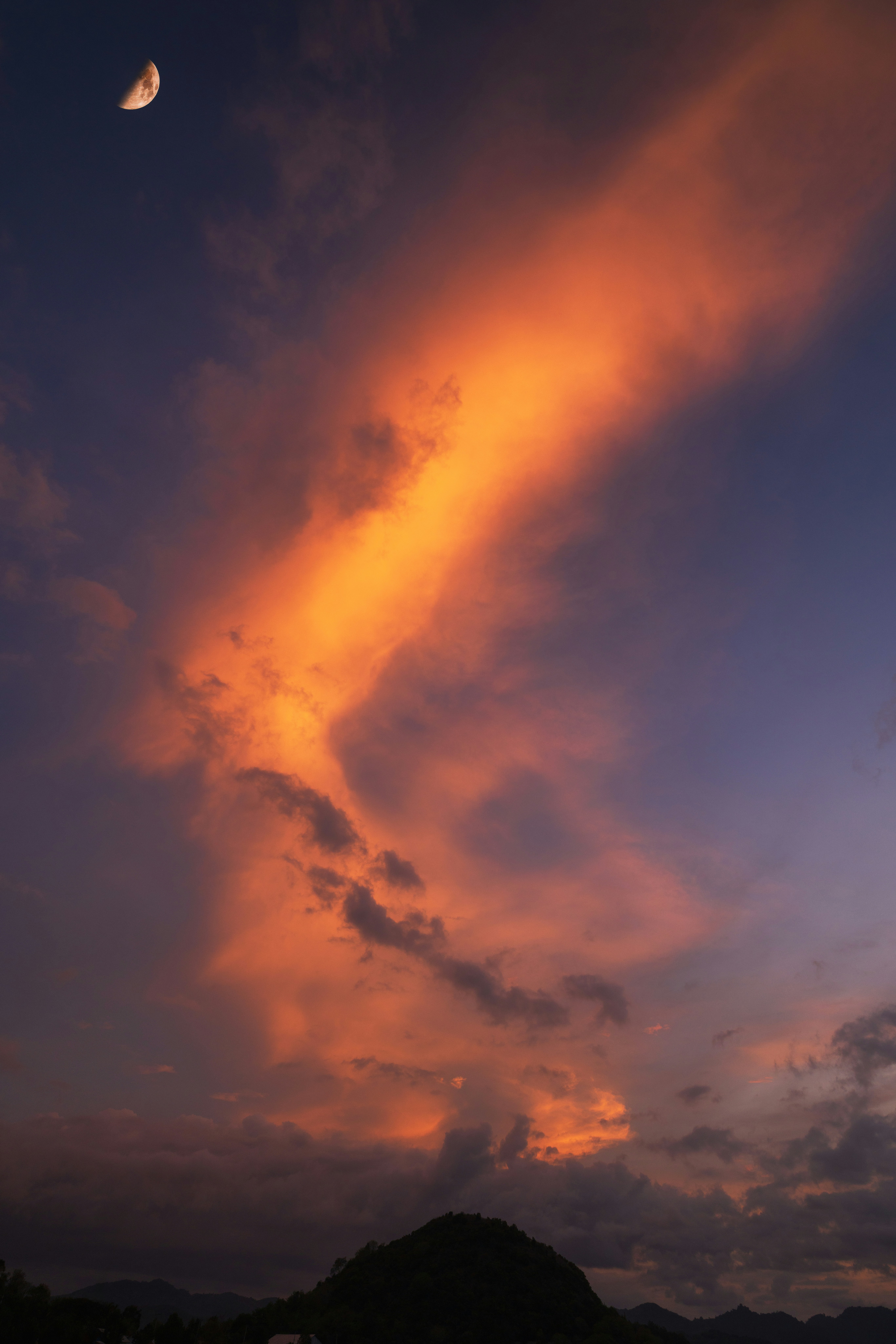 Crescent Moon over a Sunset-Flush Nebula of Cloud Fire
