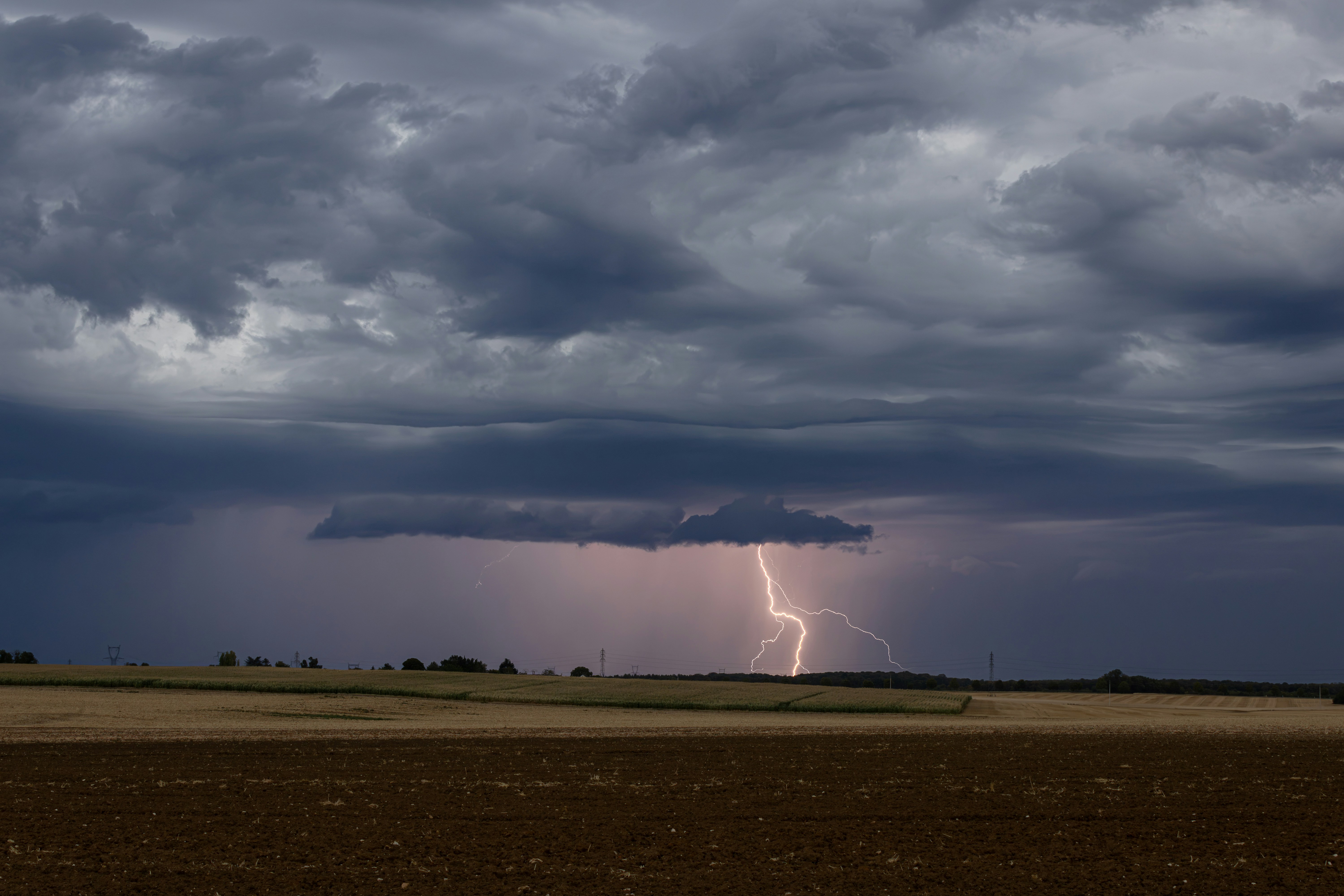 Bolt Over the Plain: Lightning Splits a Stormy Horizon