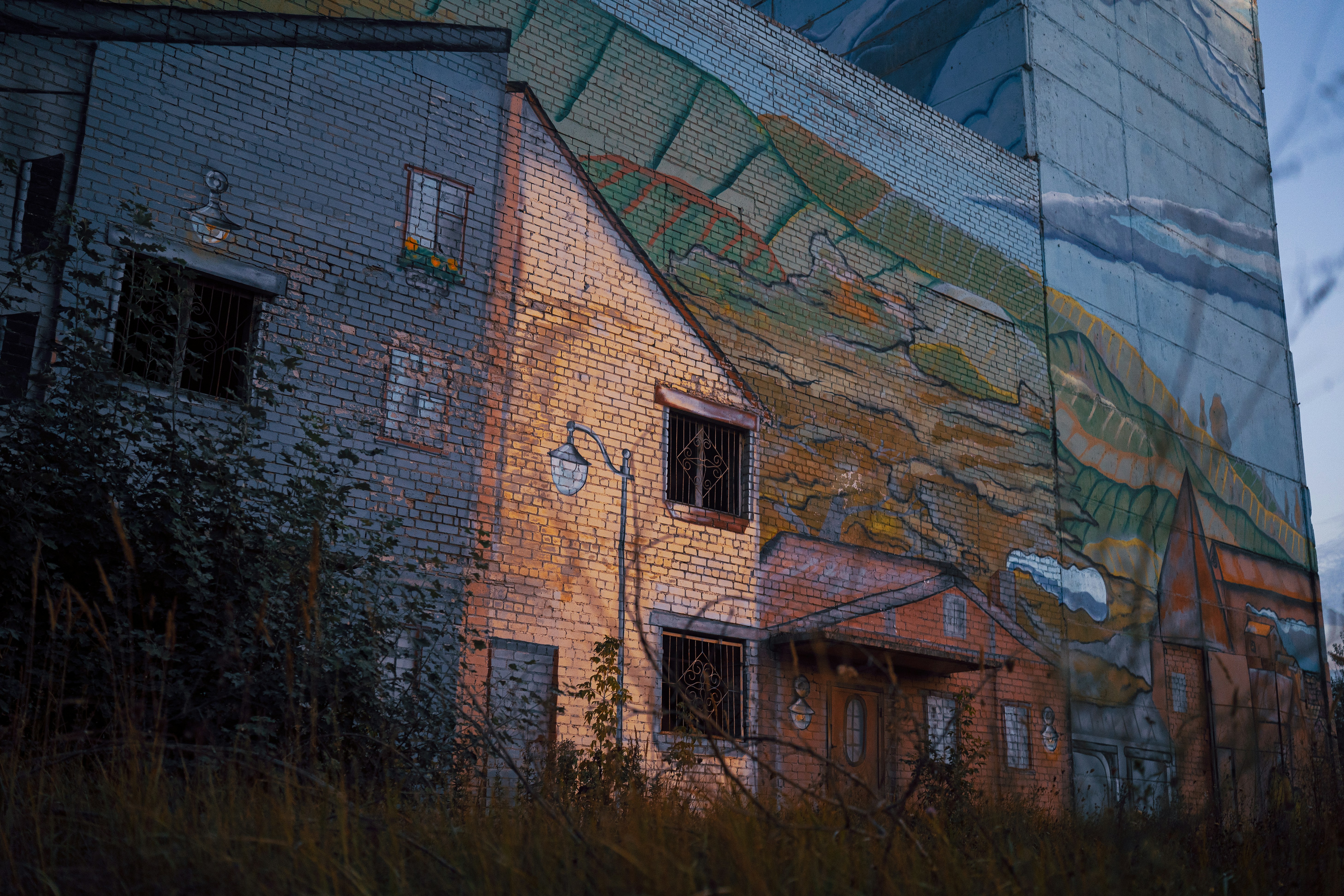 Graffiti Portraits on a Weathered Industrial Wall