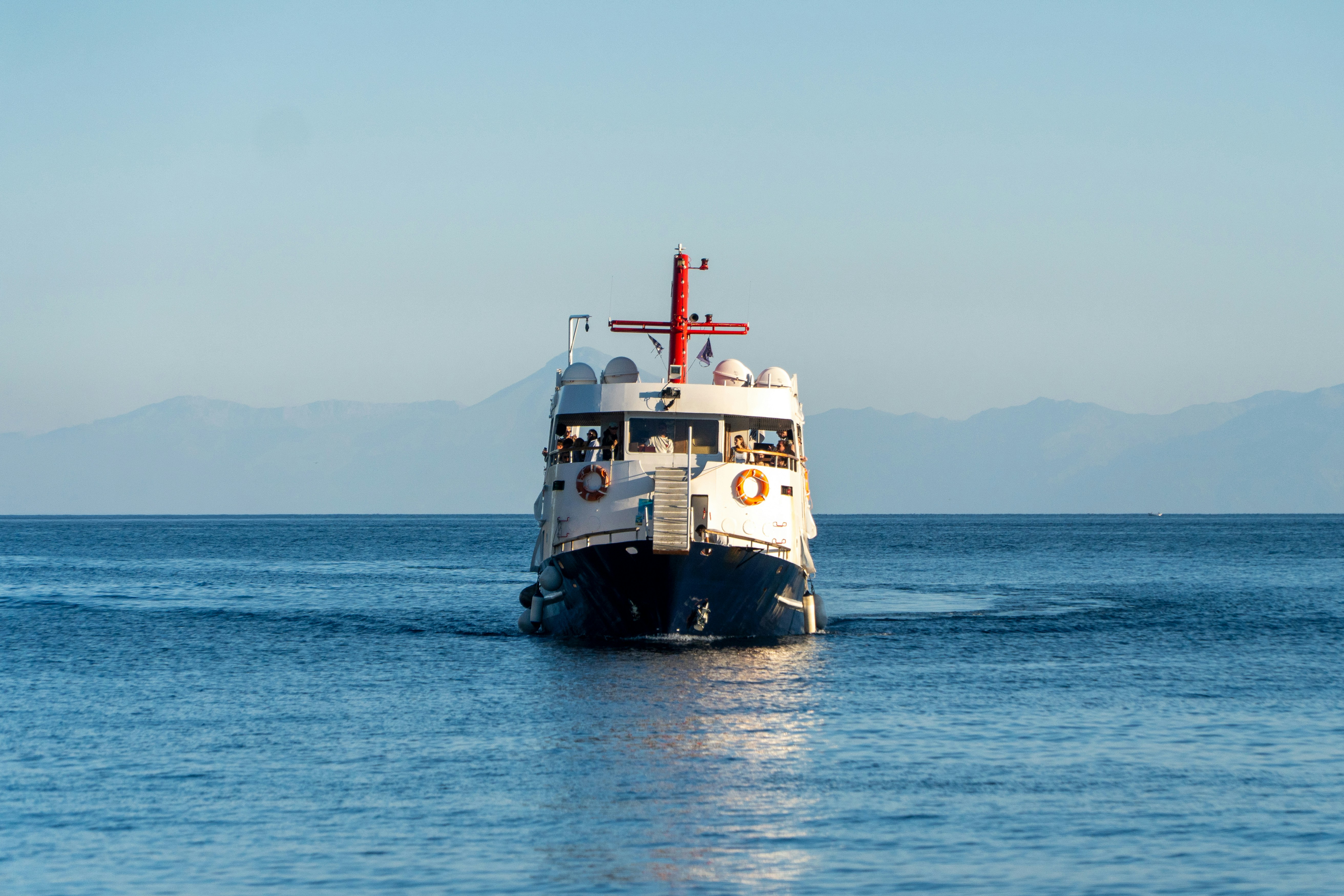 Azure Vessel: A lone ship gliding toward the horizon