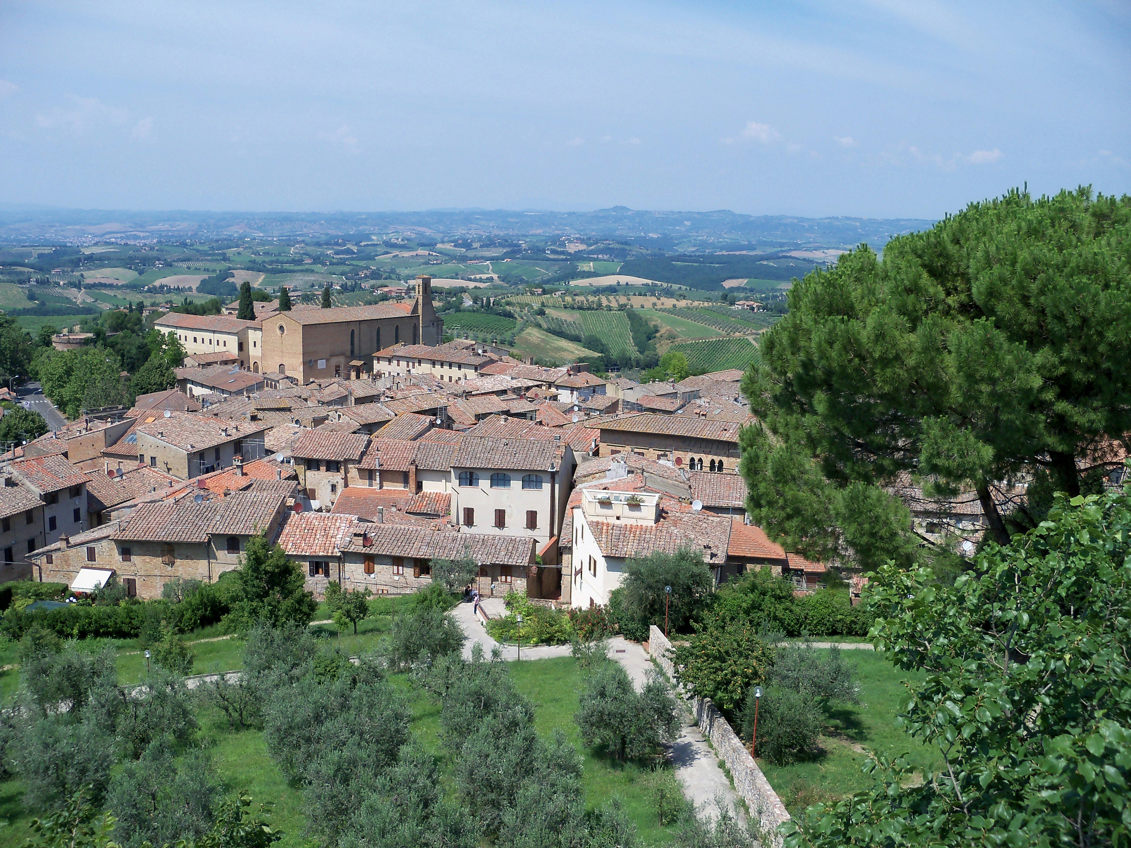 Hilltop Village of Terra Cotta Tiles under a Quiet Blue Sky