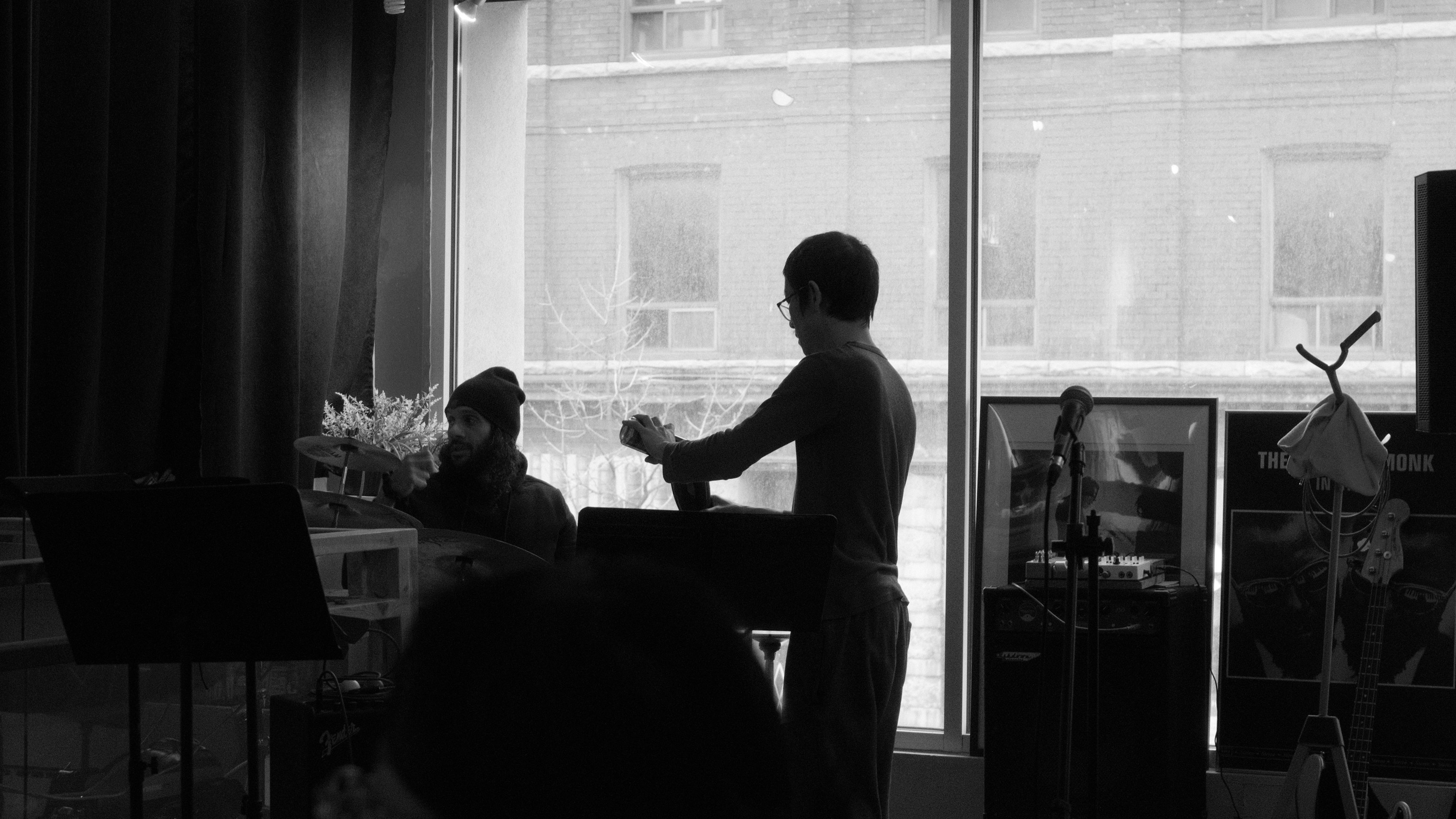 Studio silhouettes: two figures in a grayscale rehearsal by the window