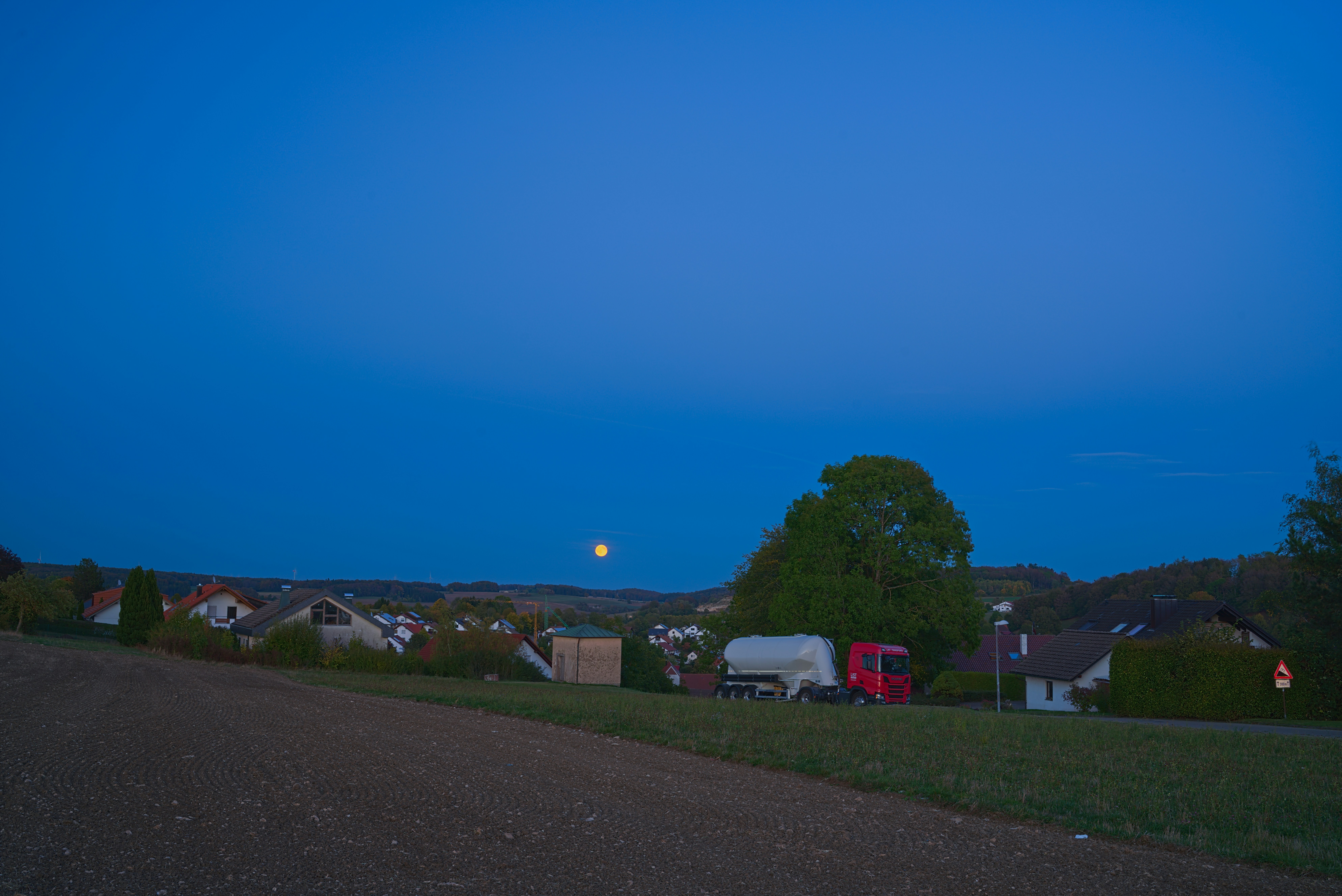 Moonrise over a quiet suburban field