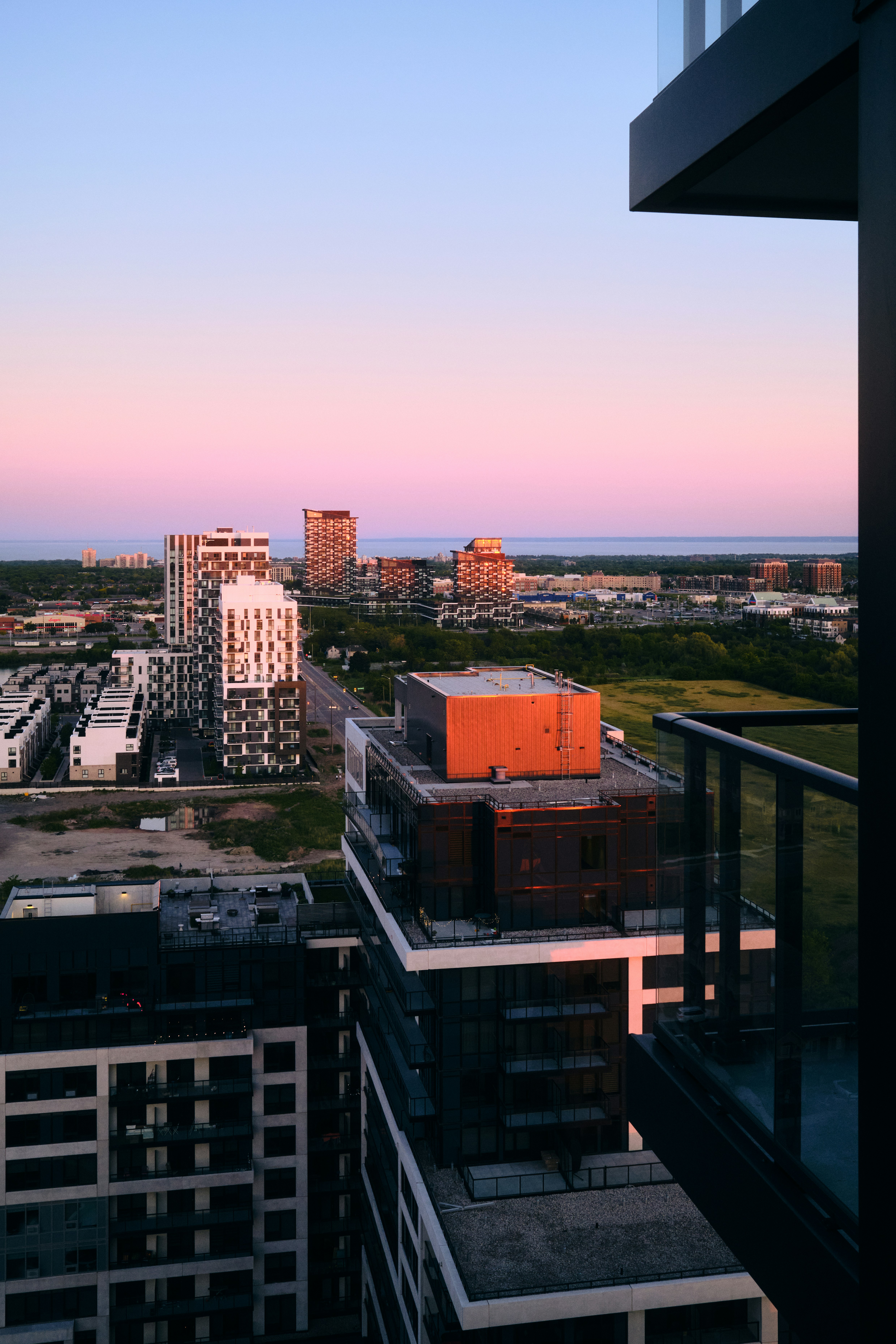 Sunset Over the Modern Skyline: Balcony Edge and Quiet Horizon