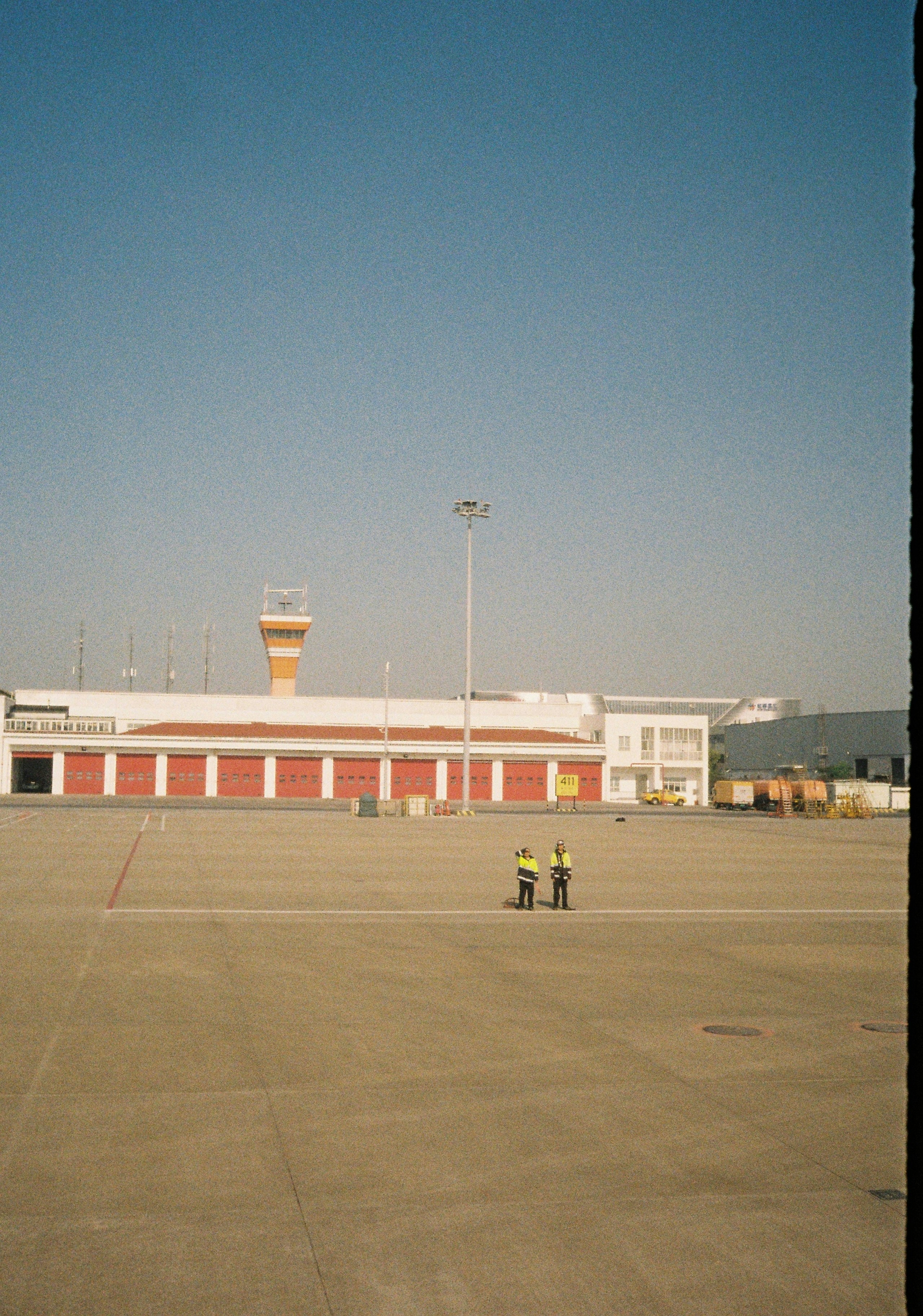 Ground Crew at Distant Gate: A Quiet Moment on the Tarmac