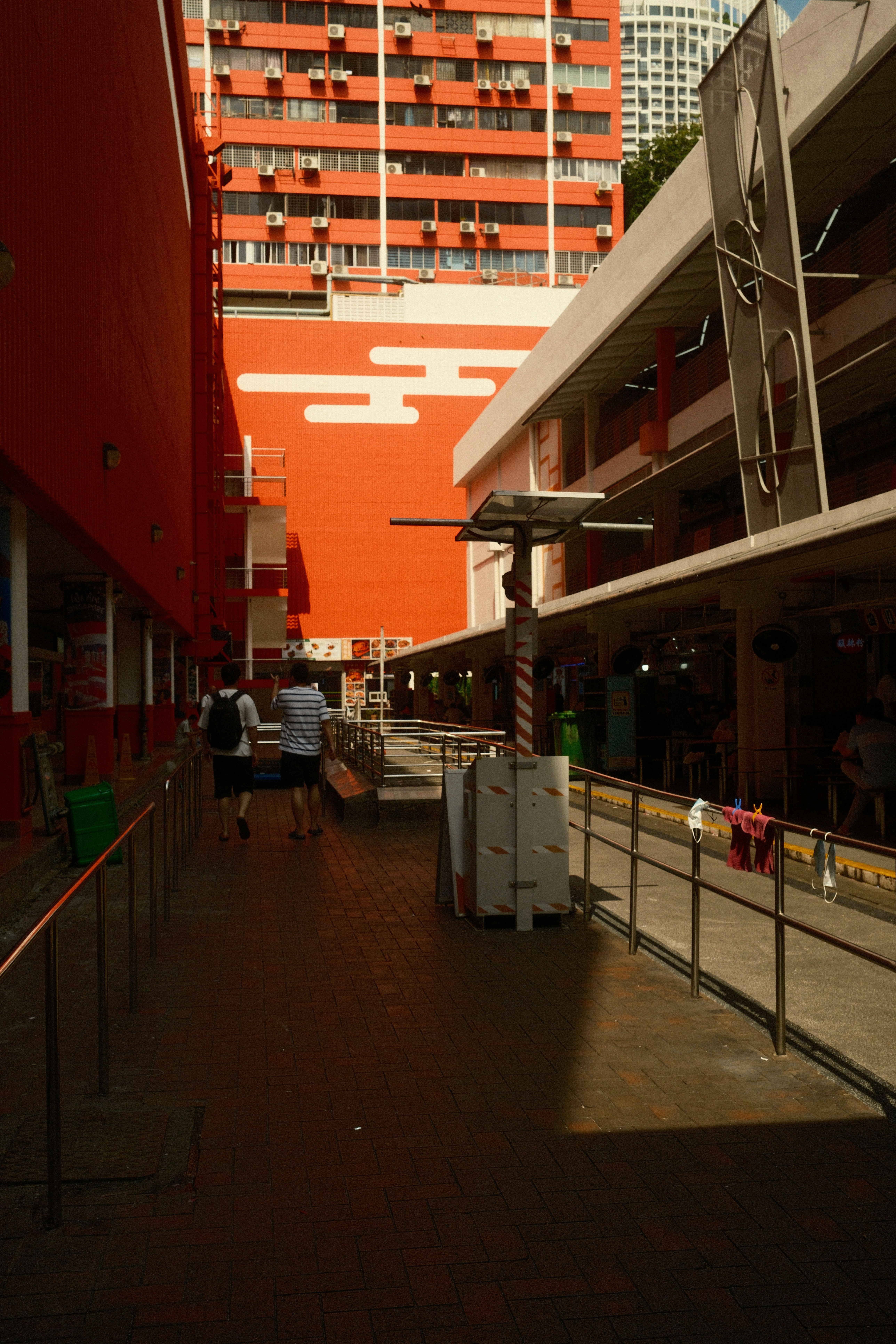 Crimson Wall and Quiet Passage: A Narrow Urban Corridor