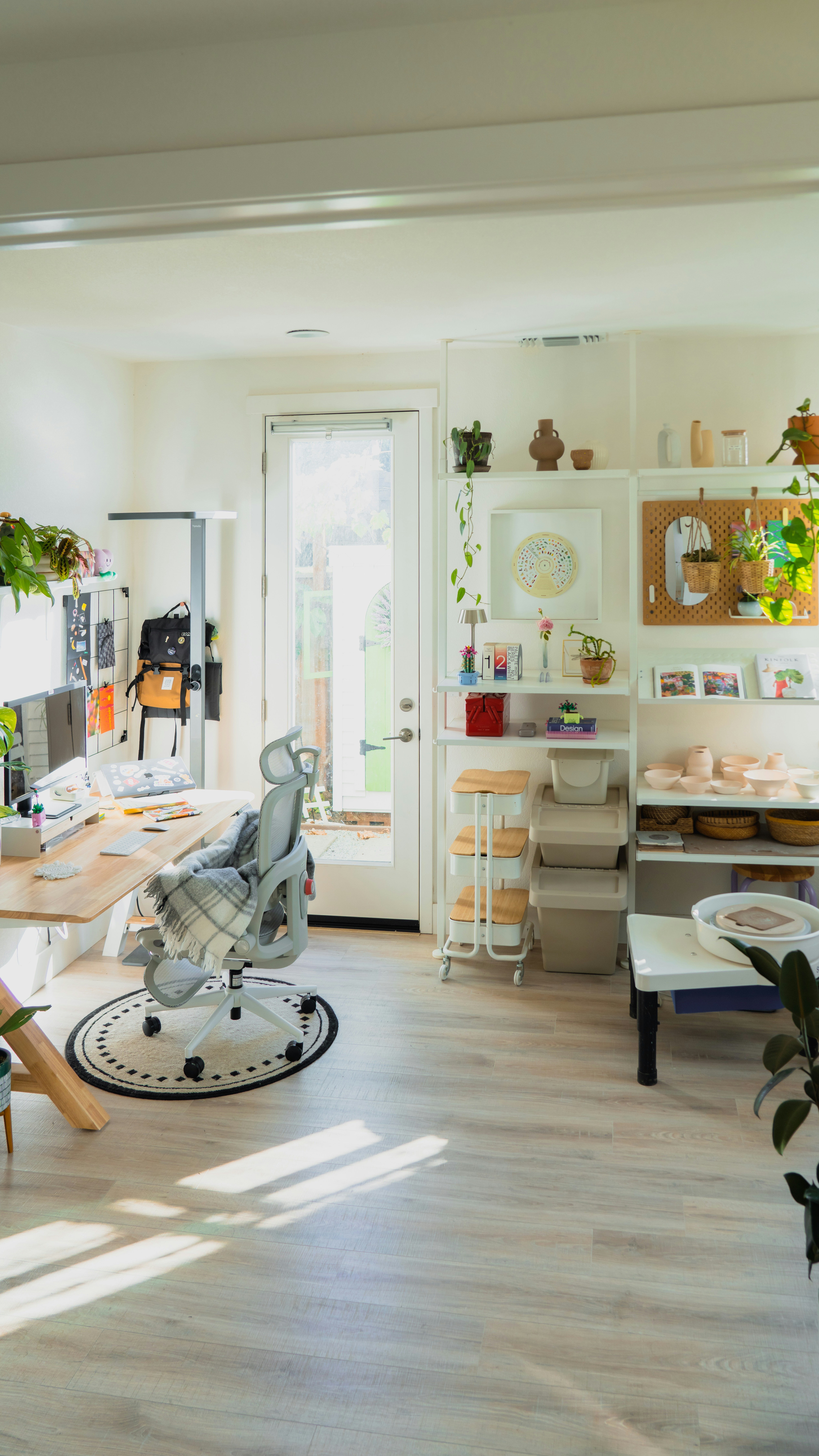 Sunlit Studio: A Calm Workspace with Plant-filled Shelves