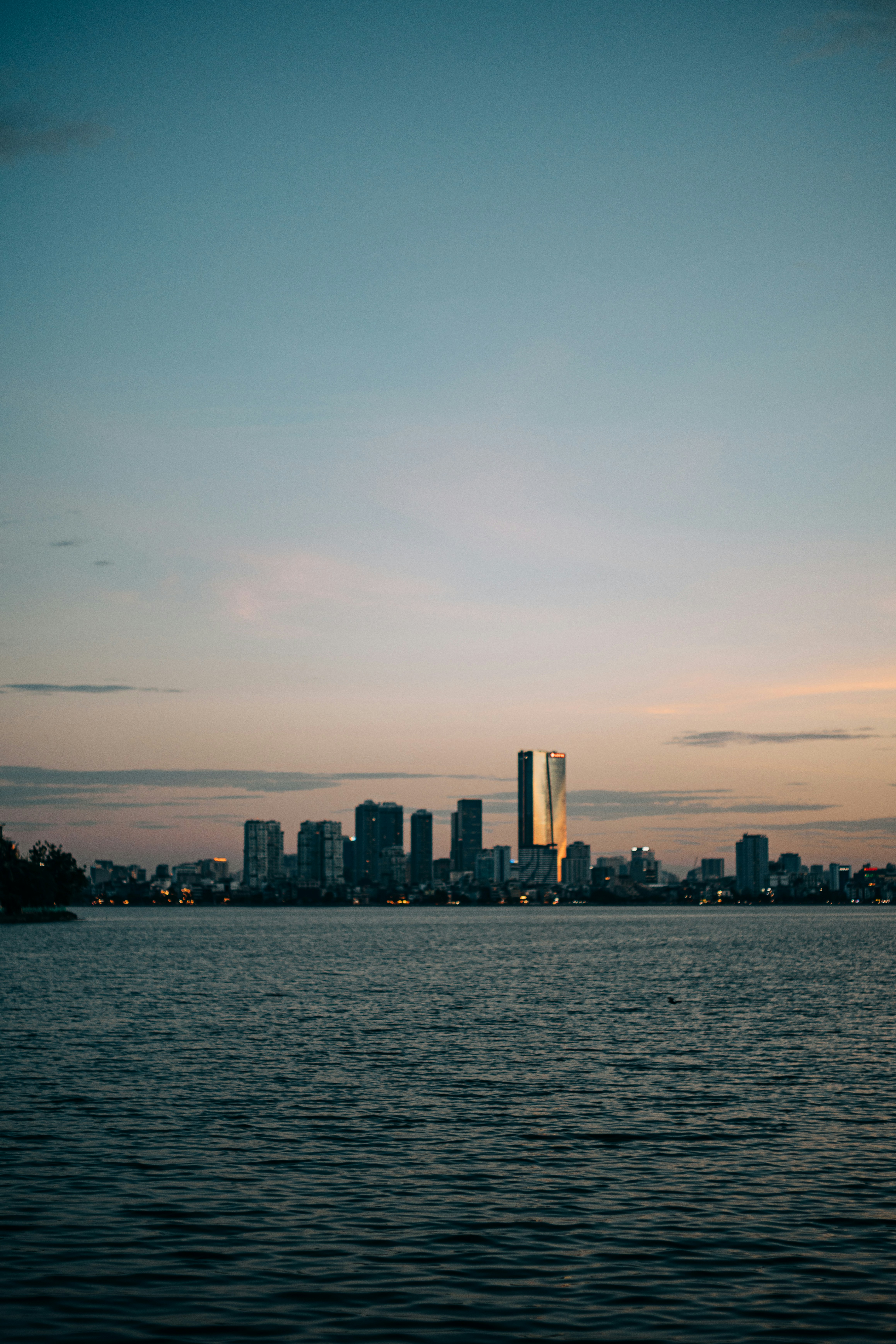 Cityscape at Dusk: A Quiet Waterfront with a Silhouette of Skyscrapers