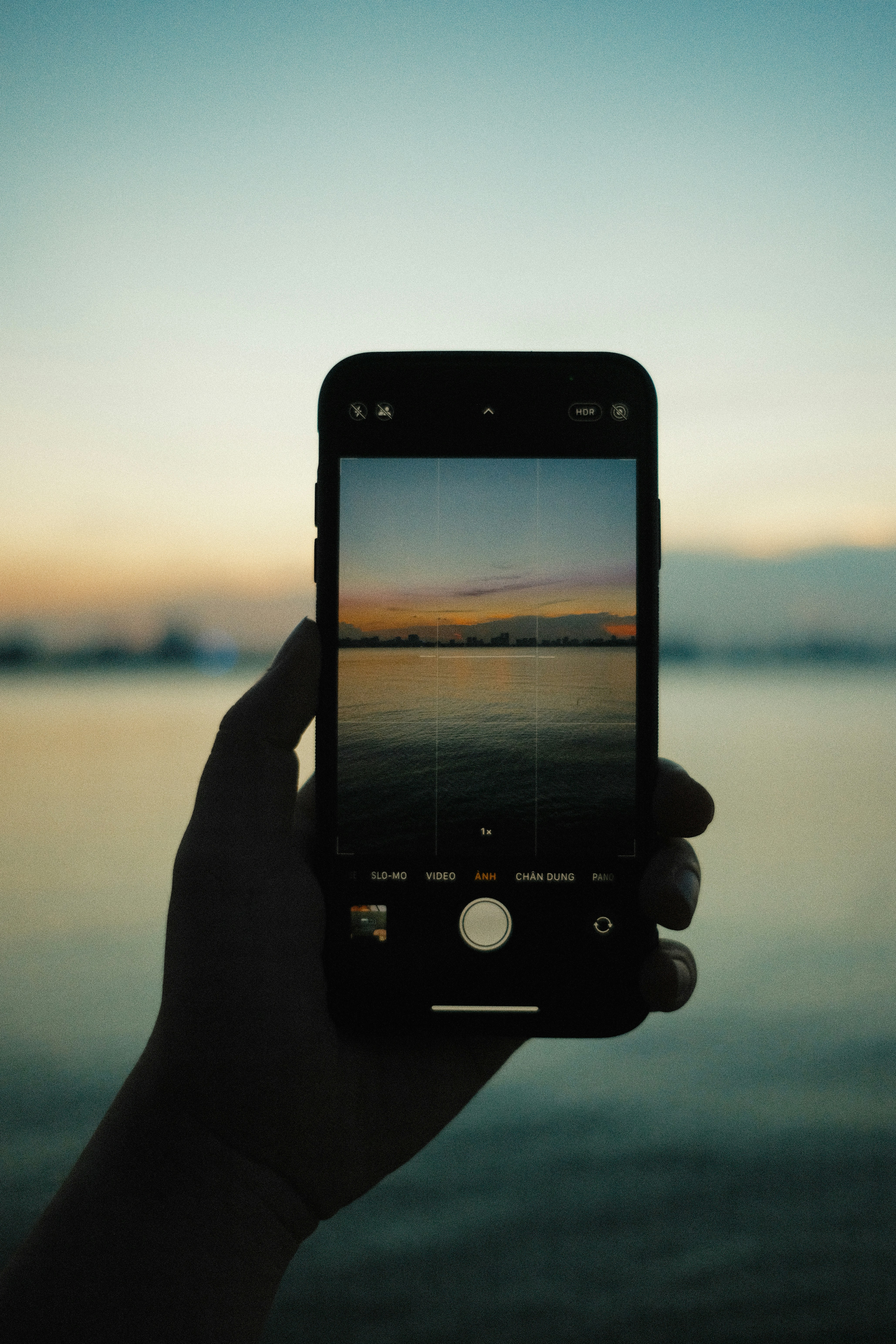 Captured Horizon: Sunset Framed by a Smartphone View