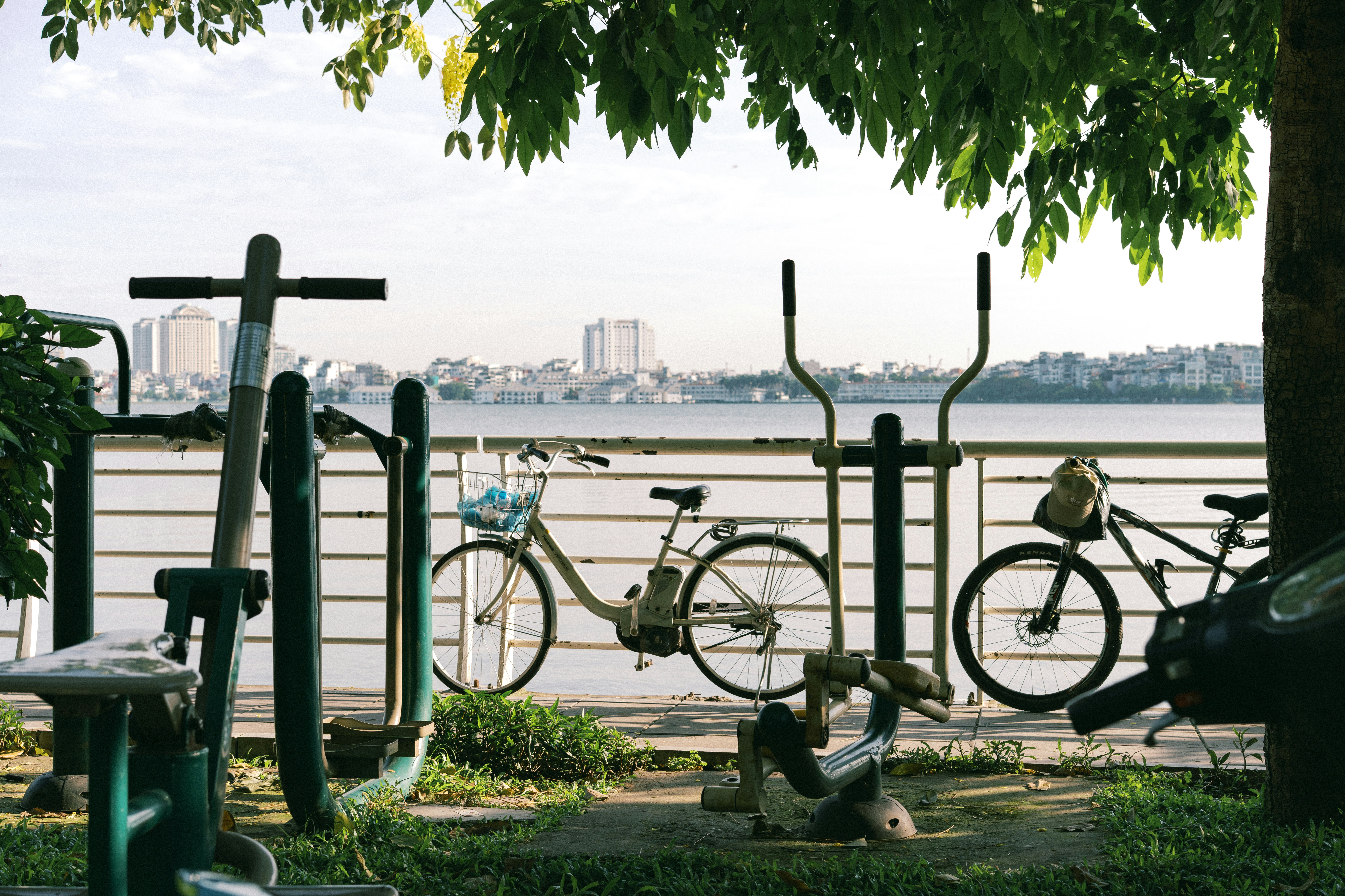 Still life by the riverside: a quiet exercise courtyard with bikes and equipment
