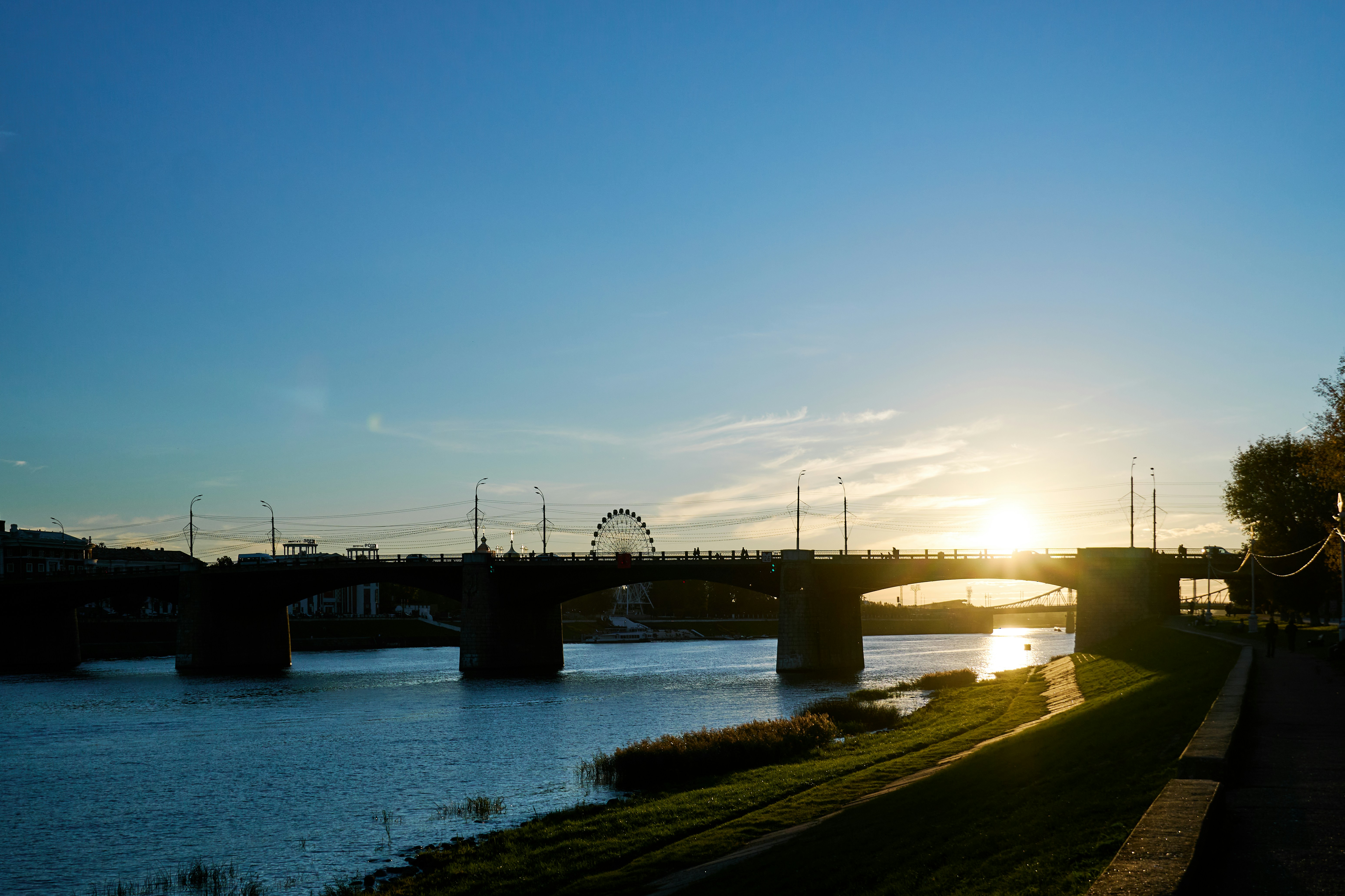 Sunlit Riverside: Evening Light Over the Bridge