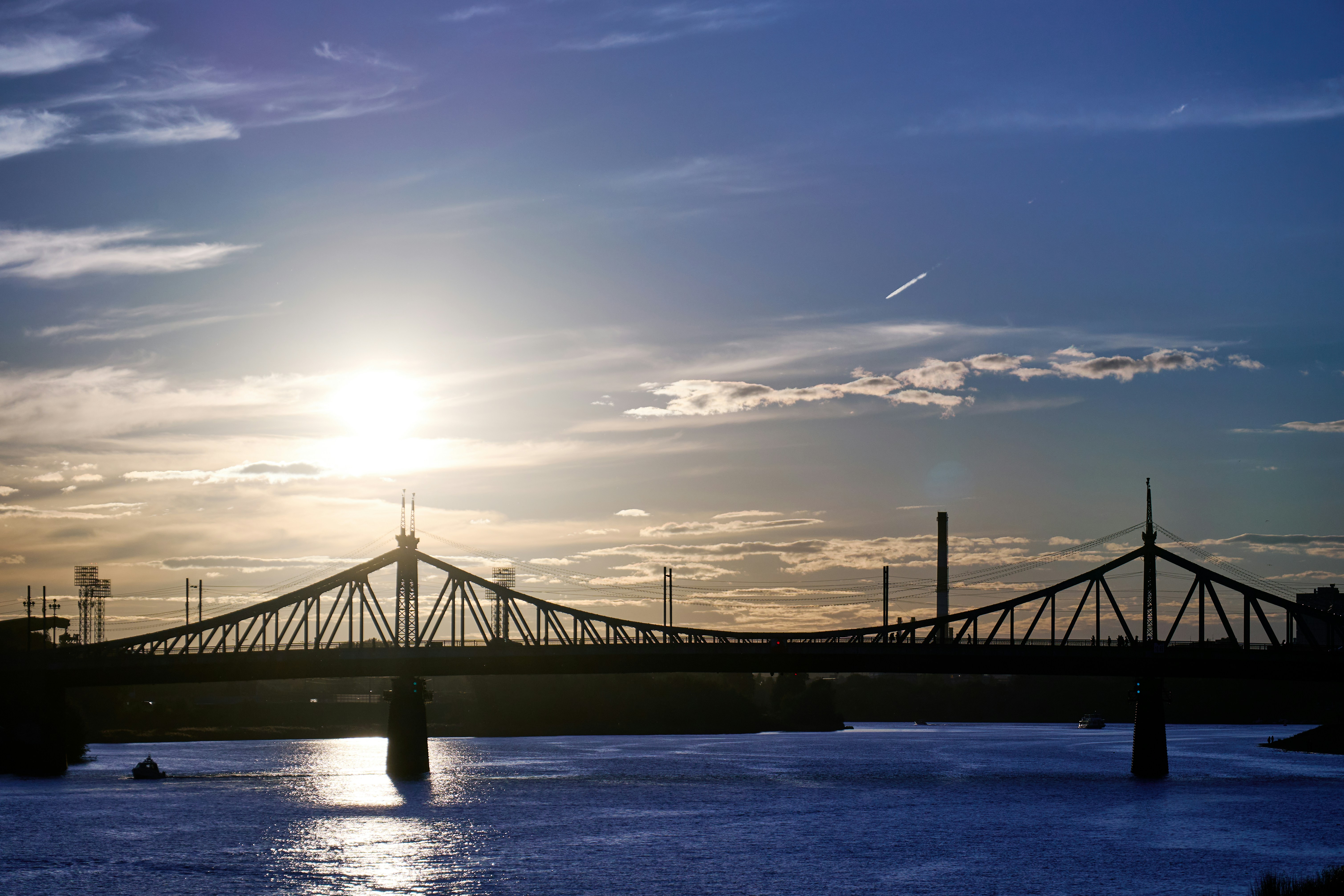 Silhouette over the River: A Bridge at Sunset