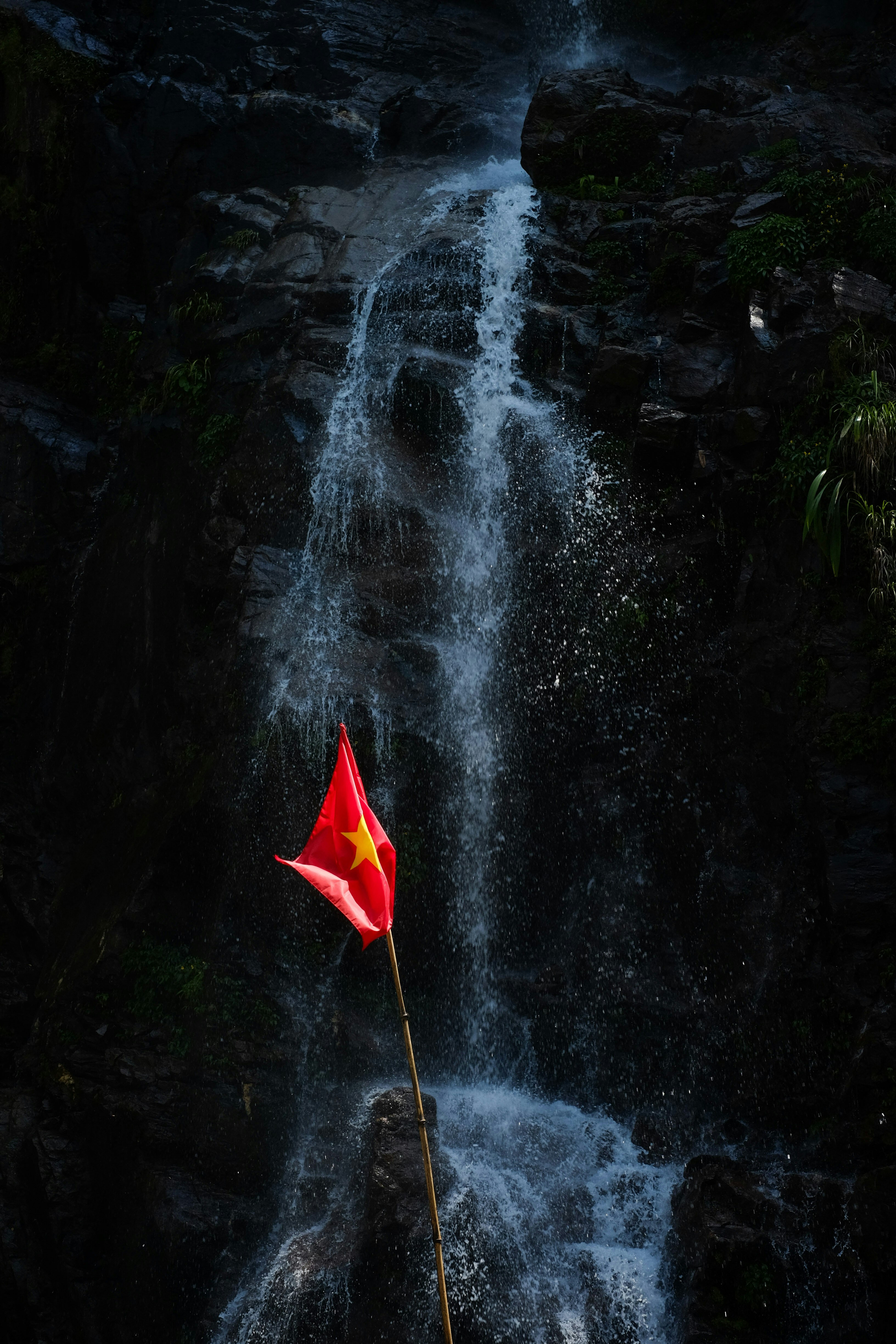 Scarlet Banner against a Hidden Cascade
