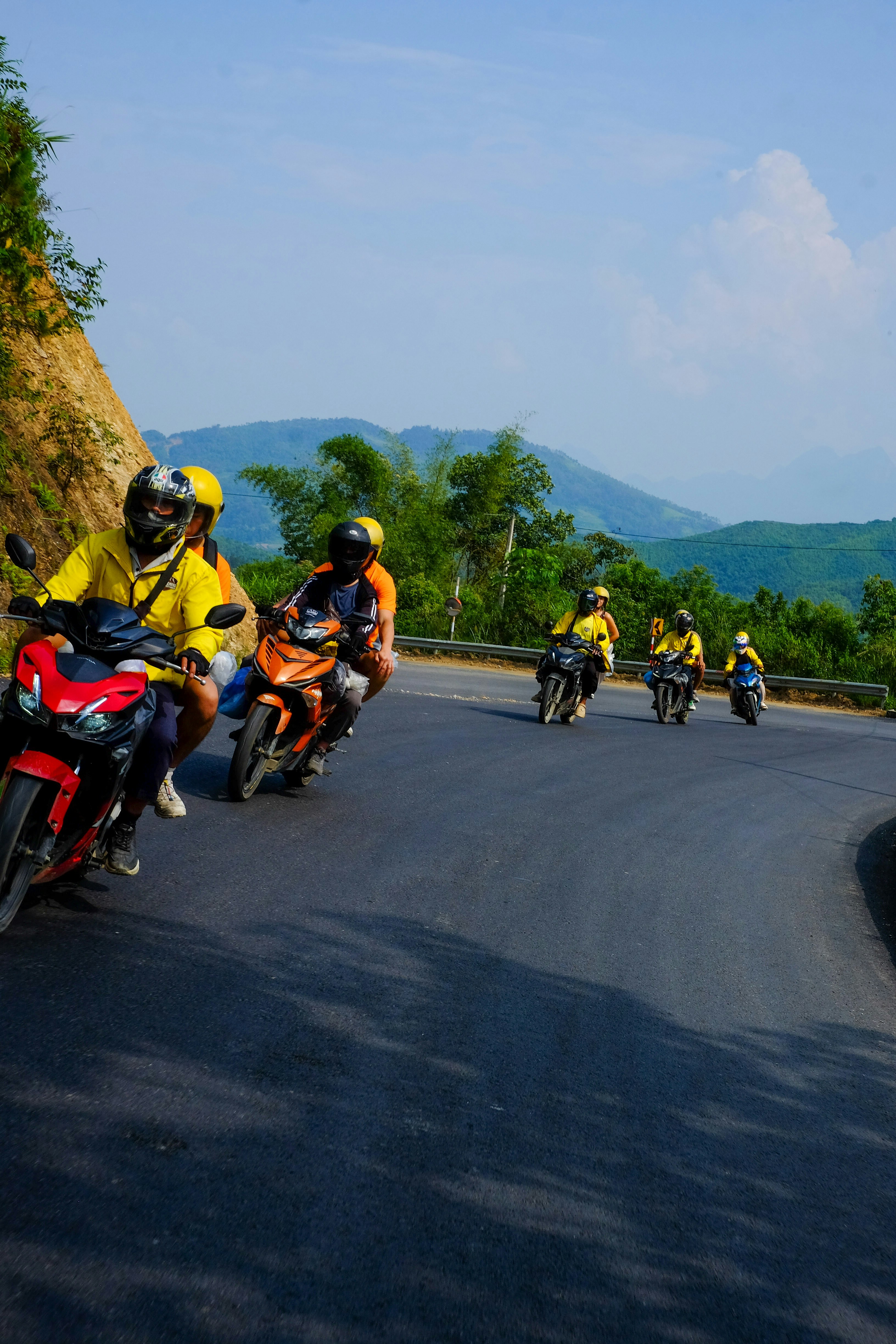 Rider Formation: A Vivid Curve of Yellow and Asphalt