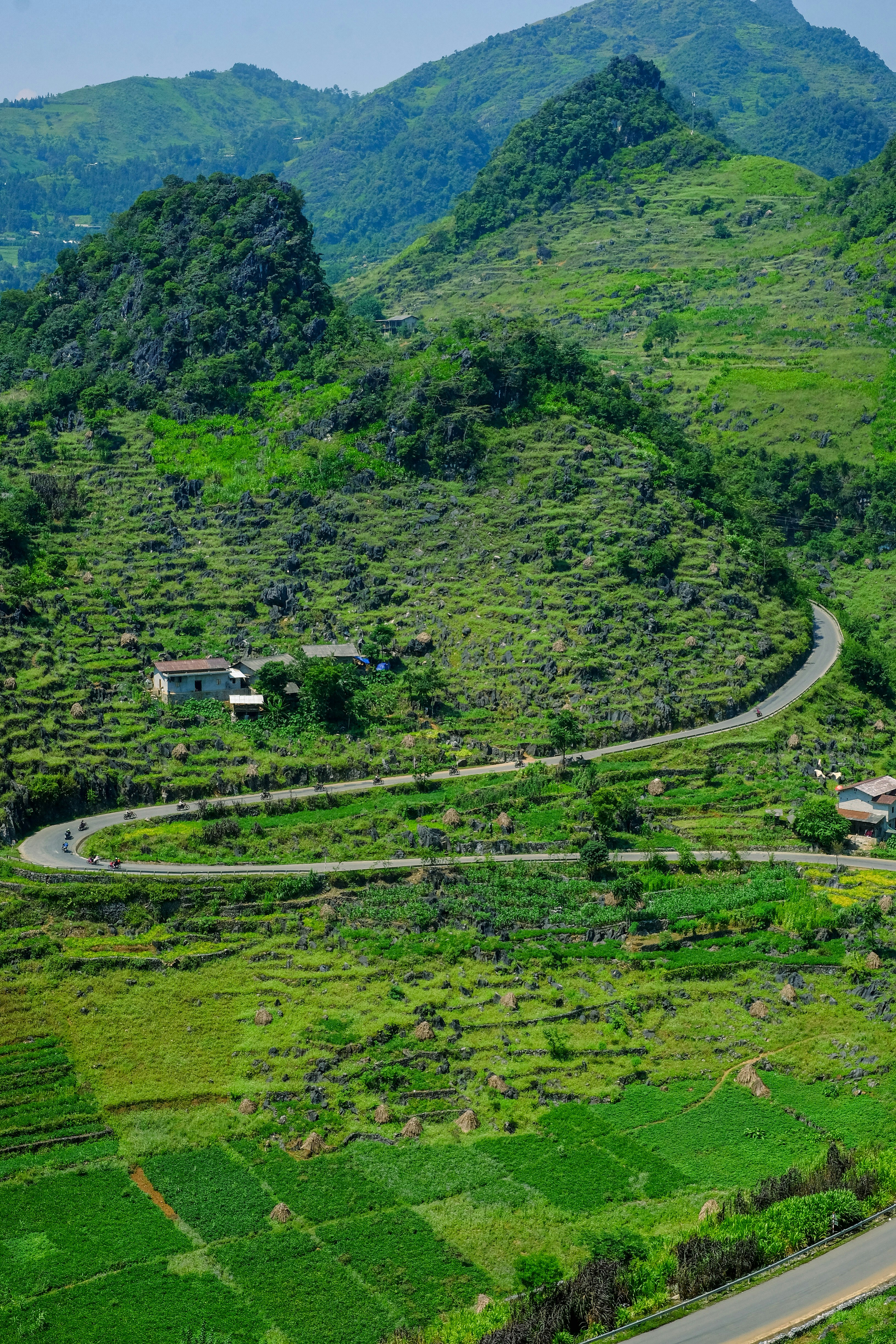 Coiled Mountain Road through Terraced Green Hills