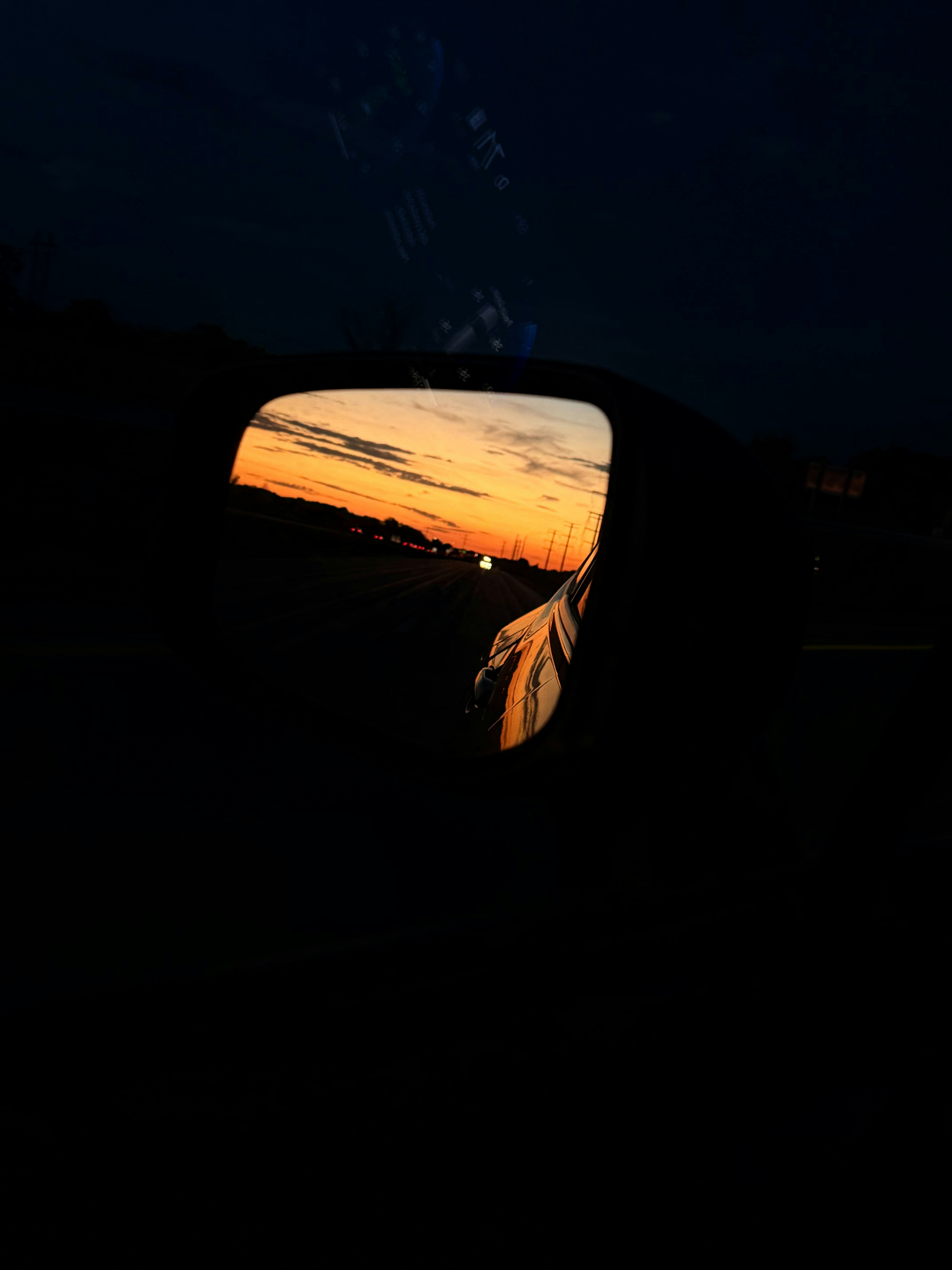 Sunset Drive-By: The Car Mirror's Quiet Glint
