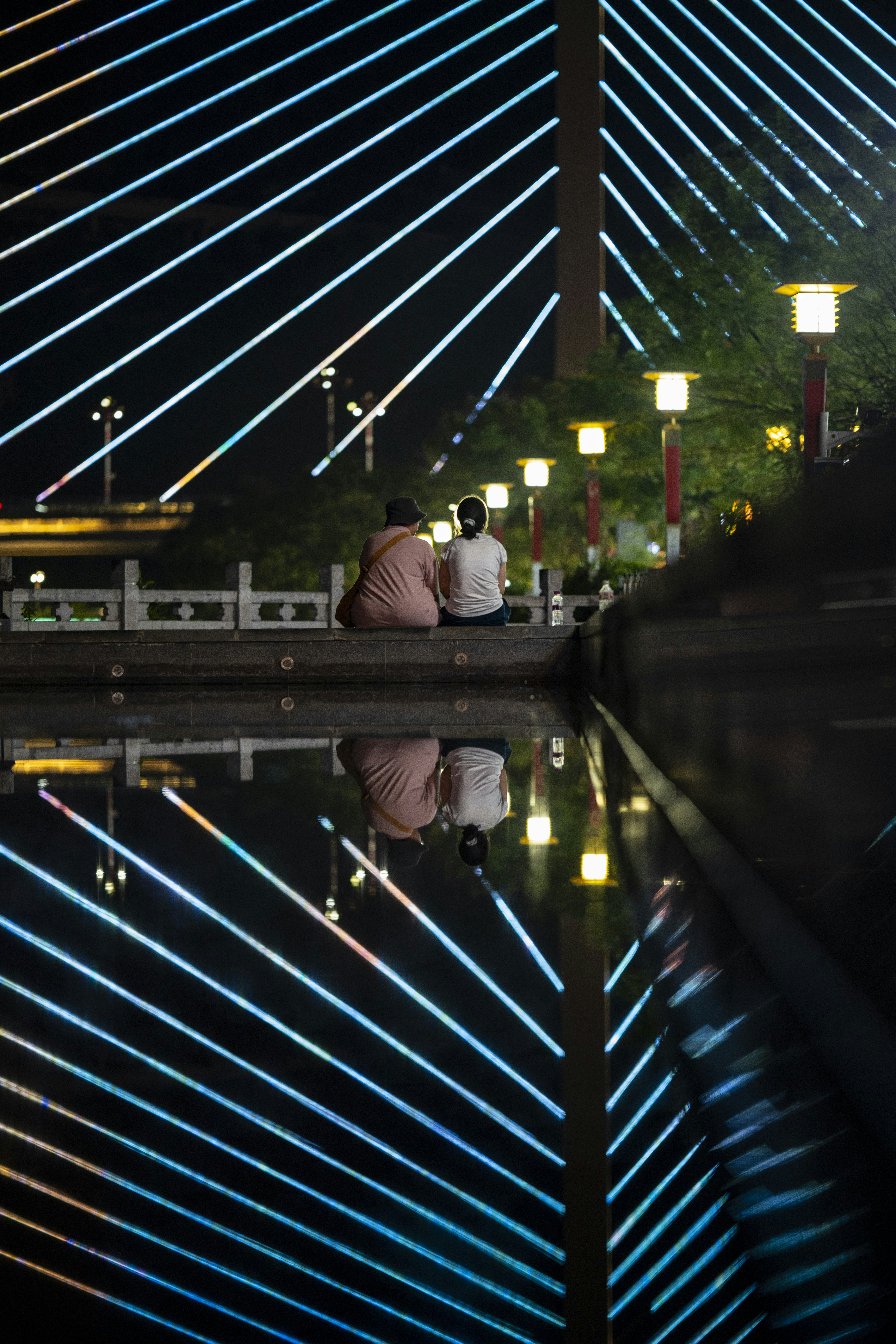 Nighttime Riverside Dialogues Under Neon Ribbons