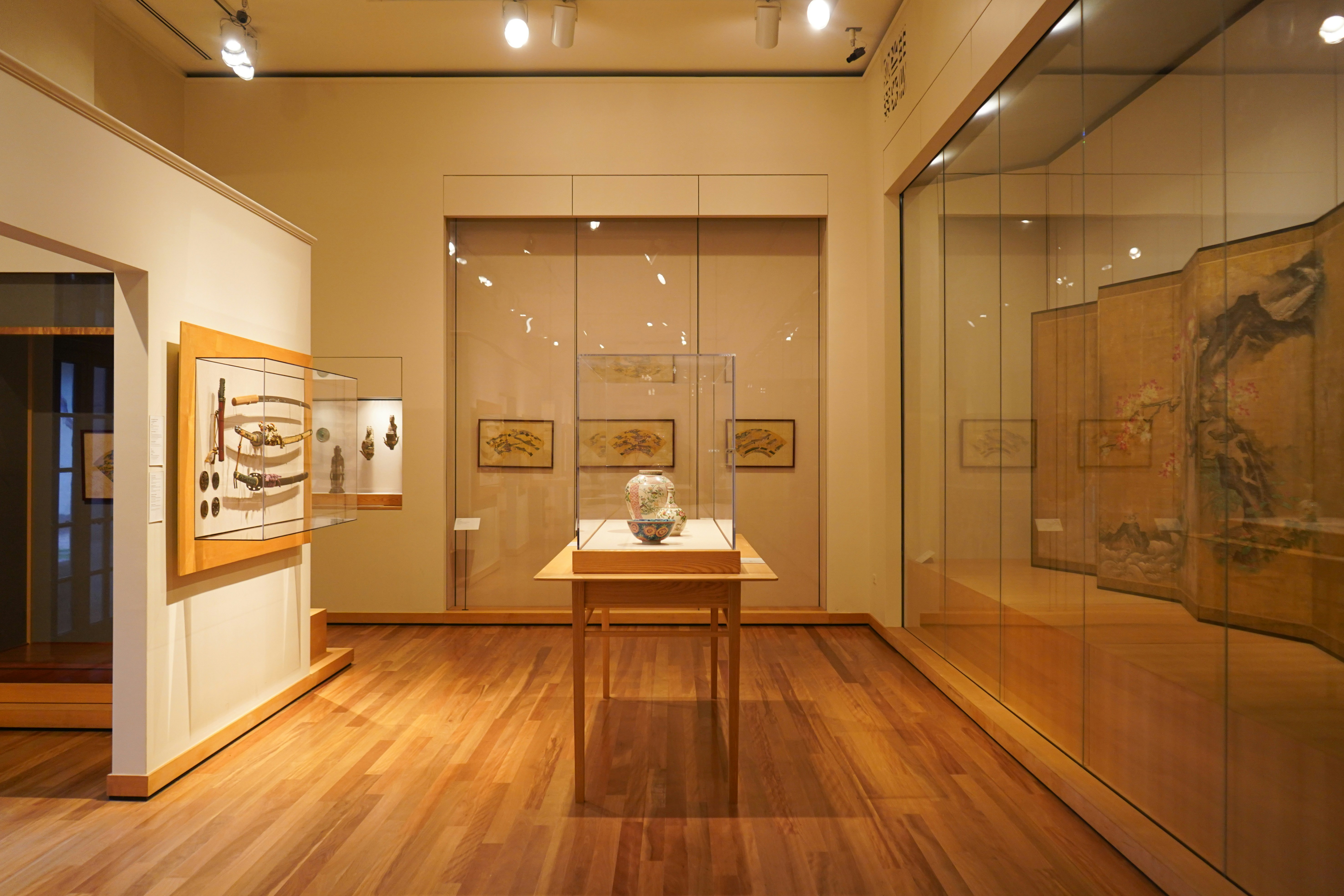Central Display Hallway: A Quiet Gallery Moment Framed by Glass and Wood