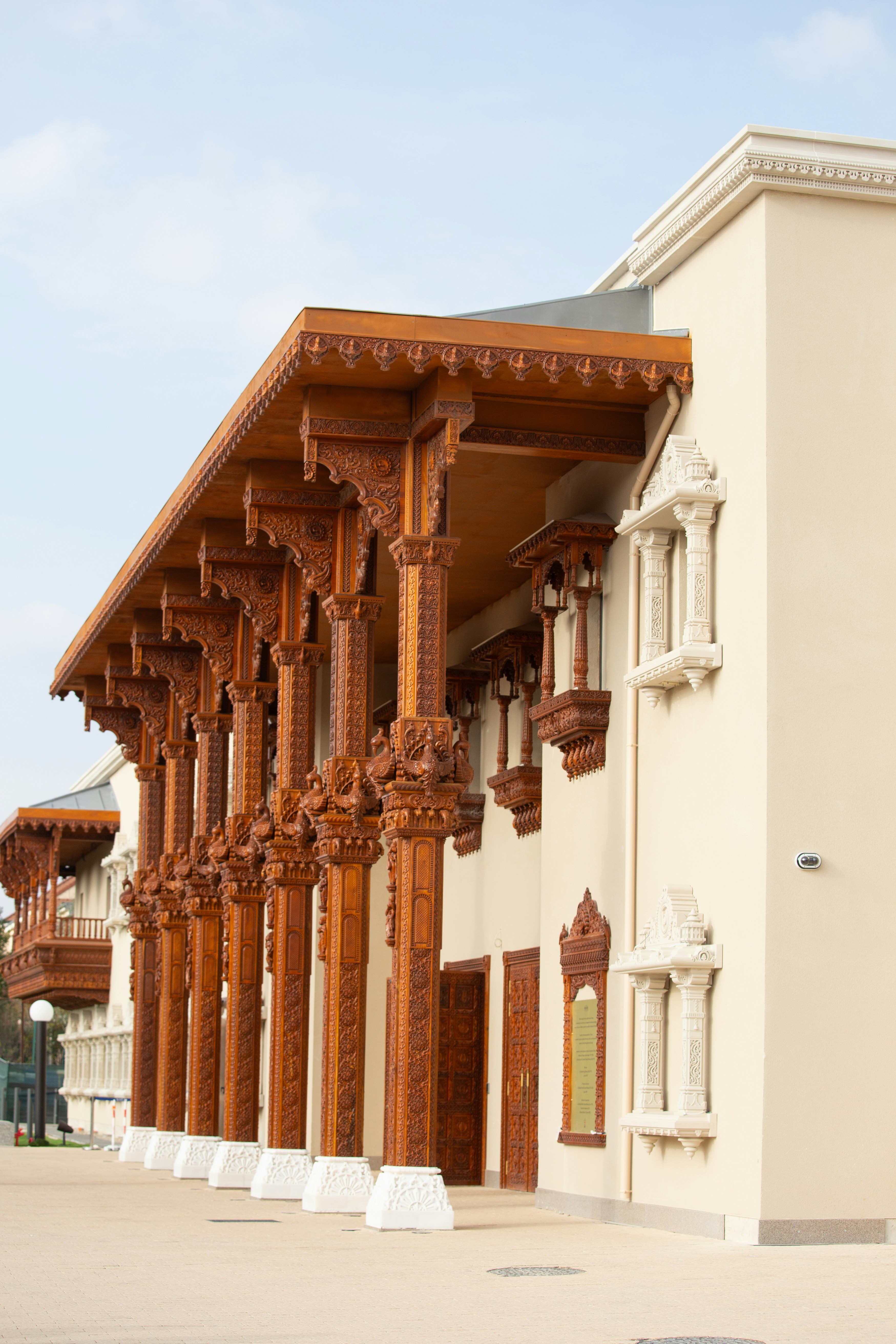 Ornate Carved Columns Stretch Along a Sunlit Facade