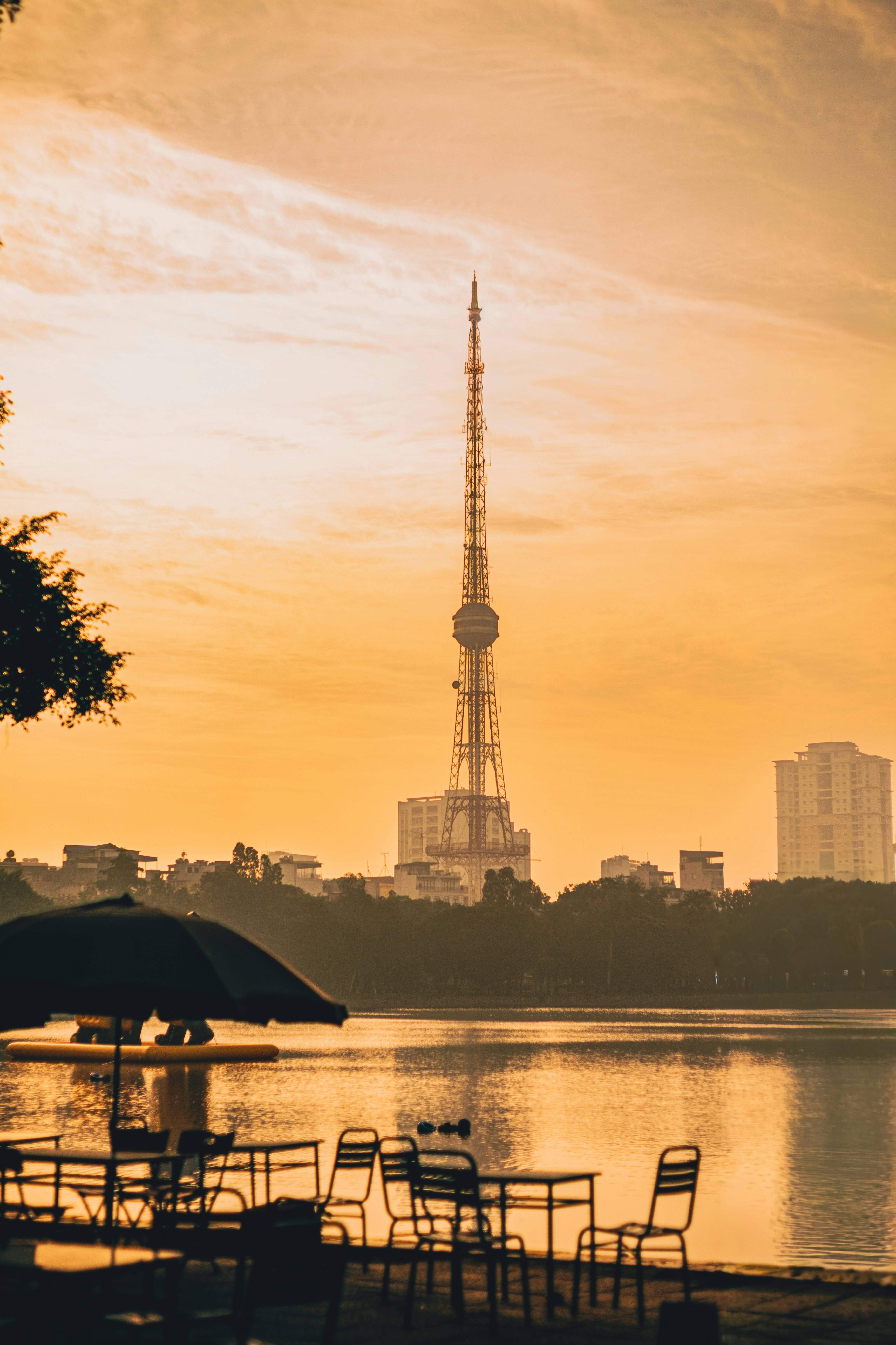 Sunset by the Waterfront: Towers on a Golden Horizon