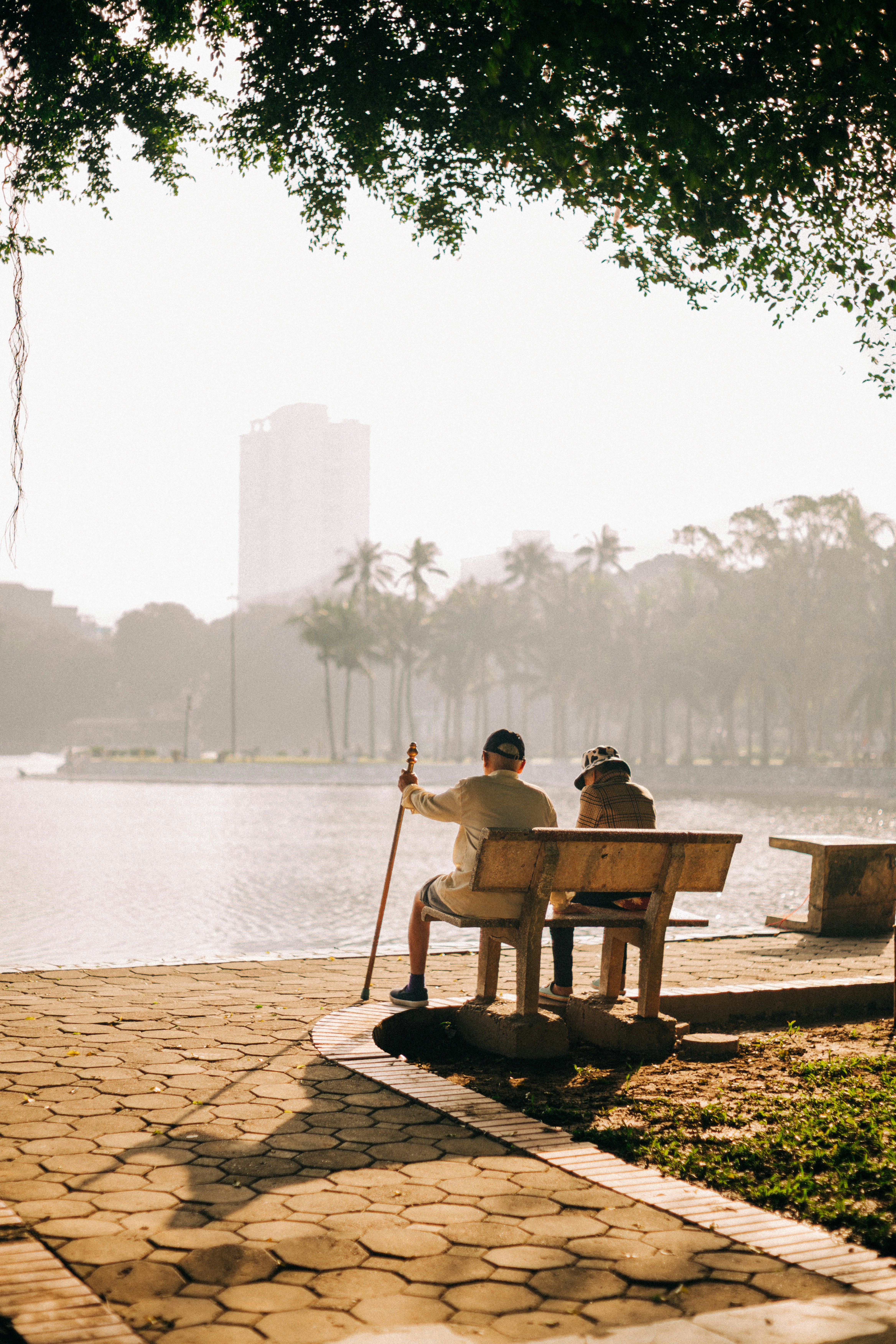 Quiet Conversation on a Riverside Bench at Dusk