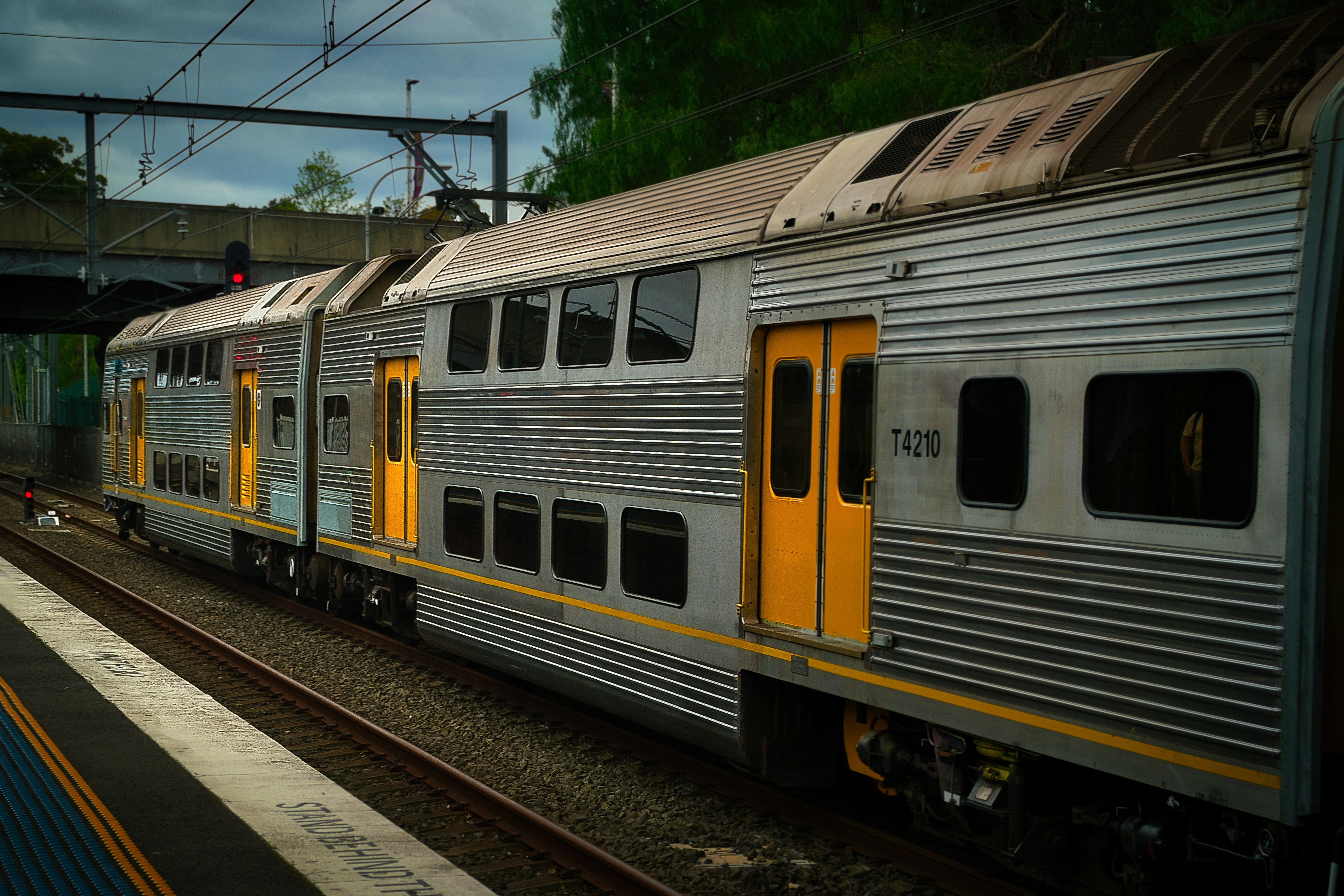 Yellow-Accented Rail Car Resting Along a Quiet Platform