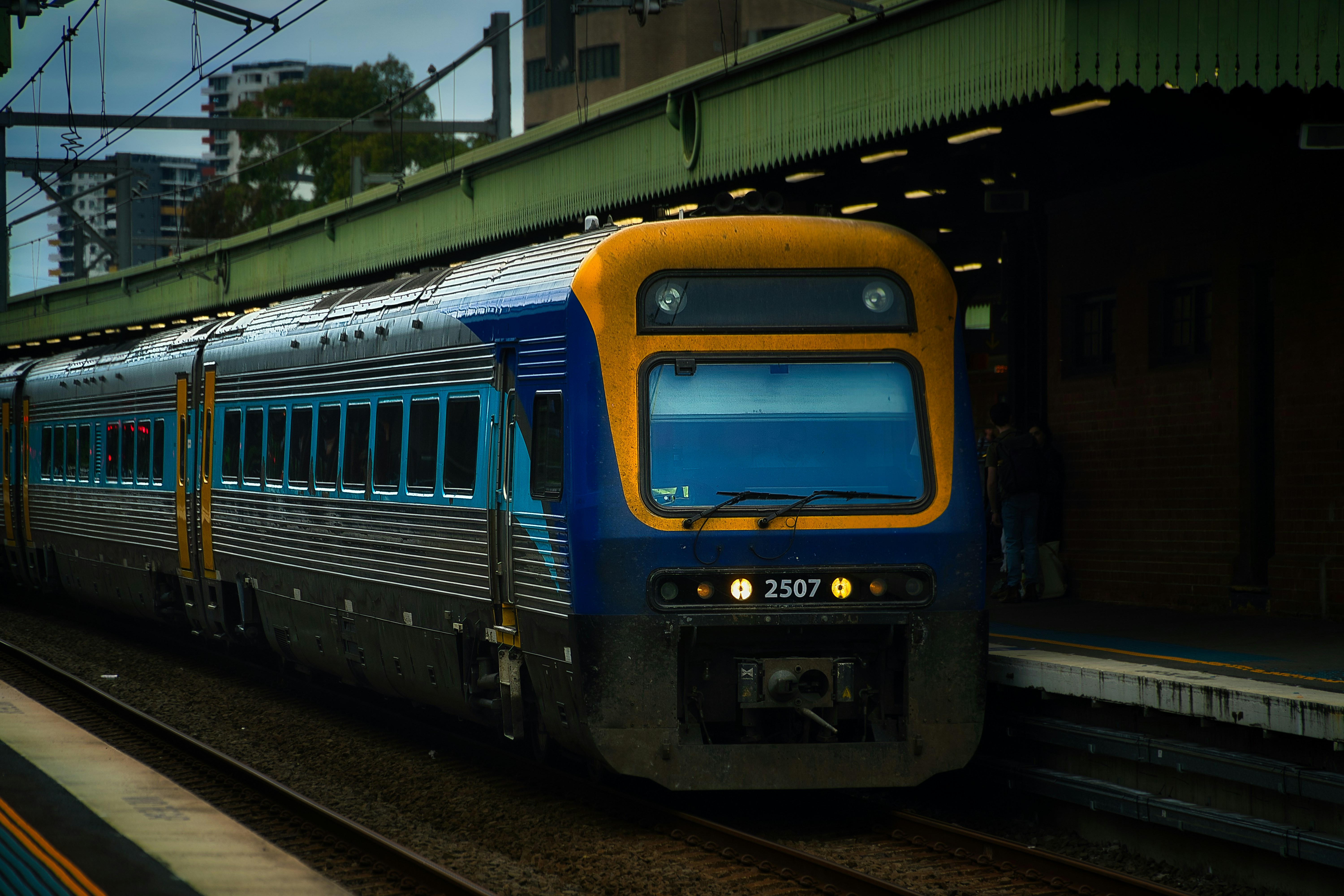 Thunder on the Rails: a blue-yellow engine at a quiet platform