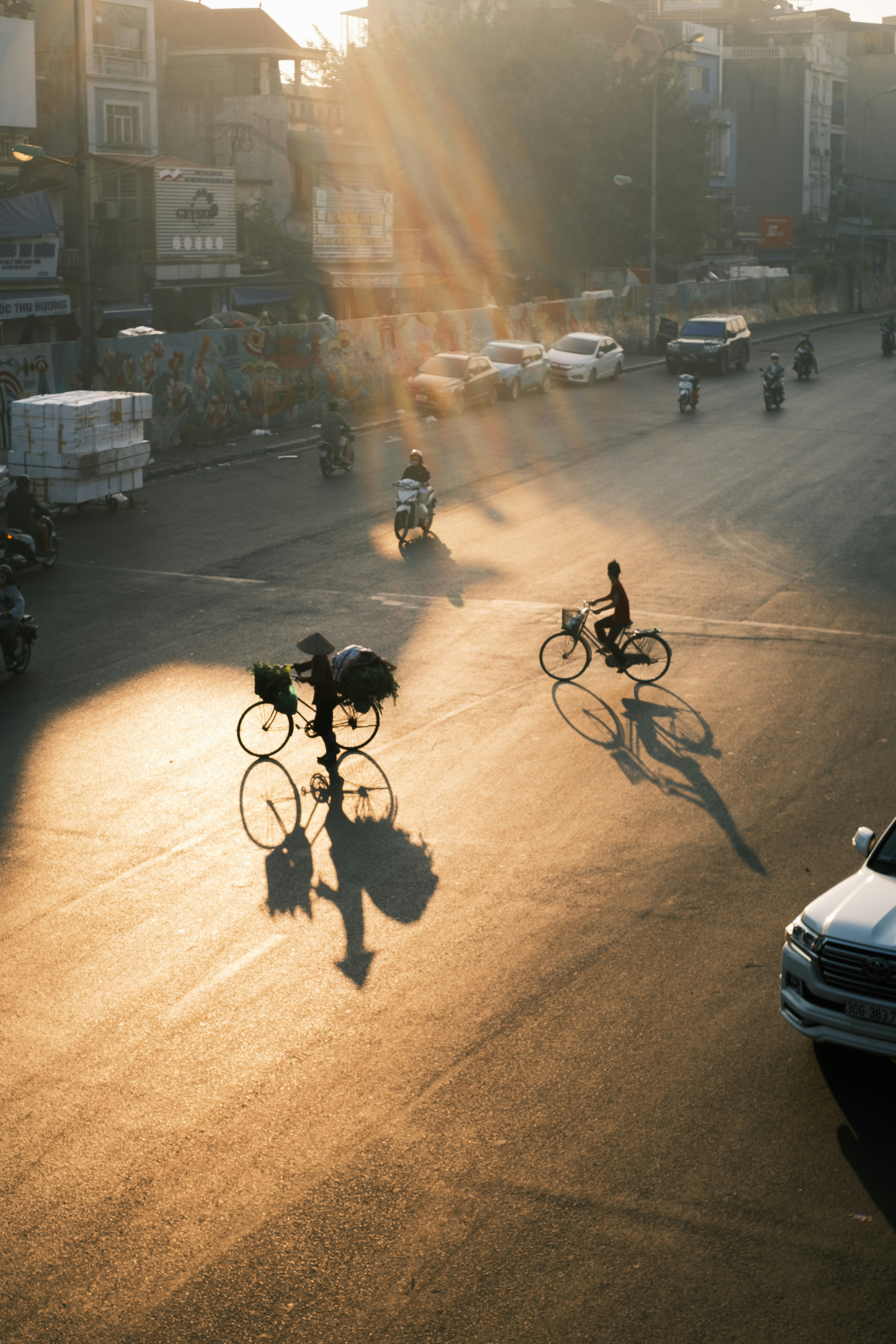 Golden Hour Relay: Bicycles and Riders Casting Long Shadows