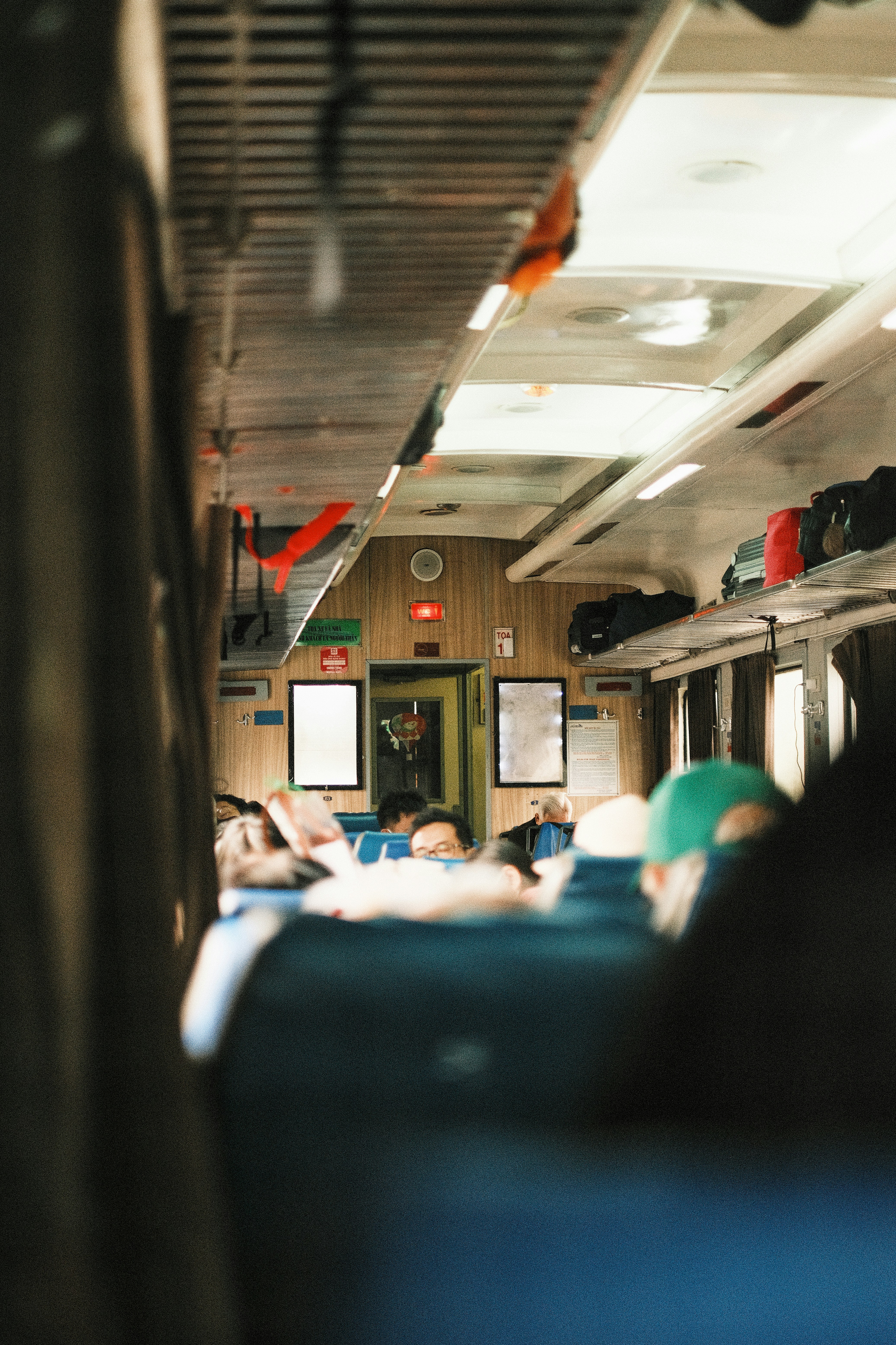Crowded Train Car: A Glimpse Toward the Door as Passengers Sail By