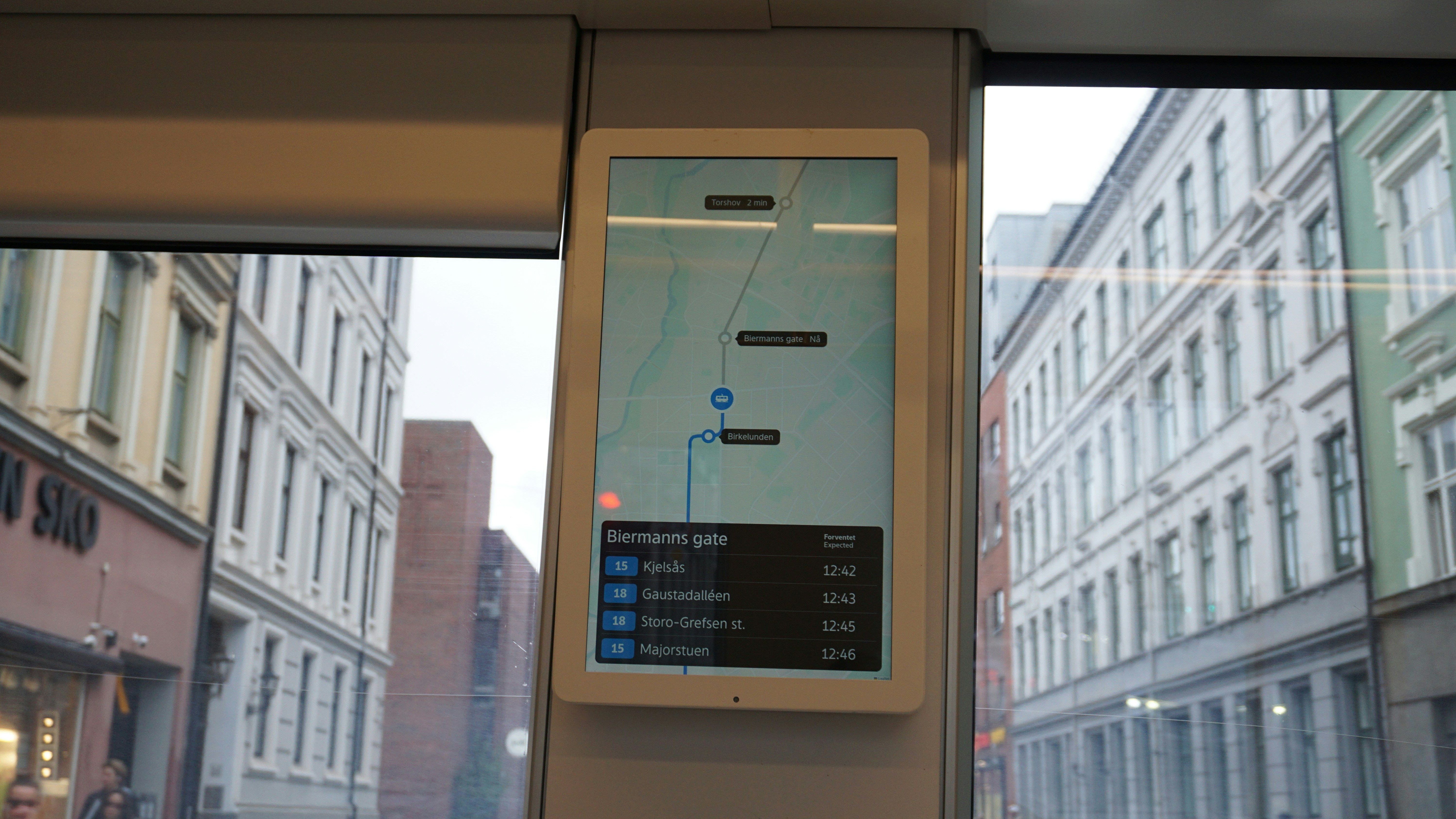 Transit Hub Screen: A City’s Quiet Pulse Reflected in Glass and Maps