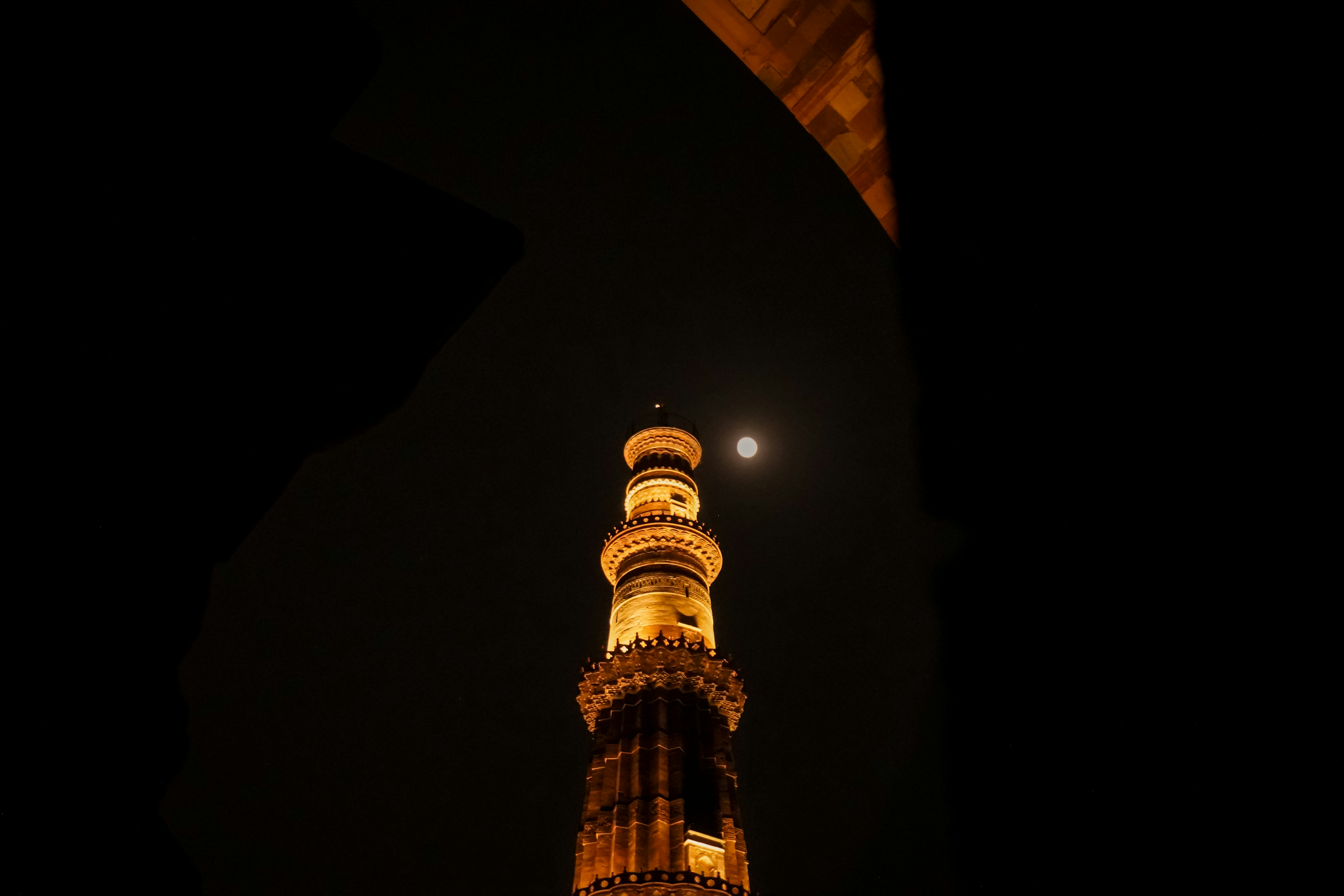Moonlit Minaret: A Nighttime Flight of Warm Lanterns